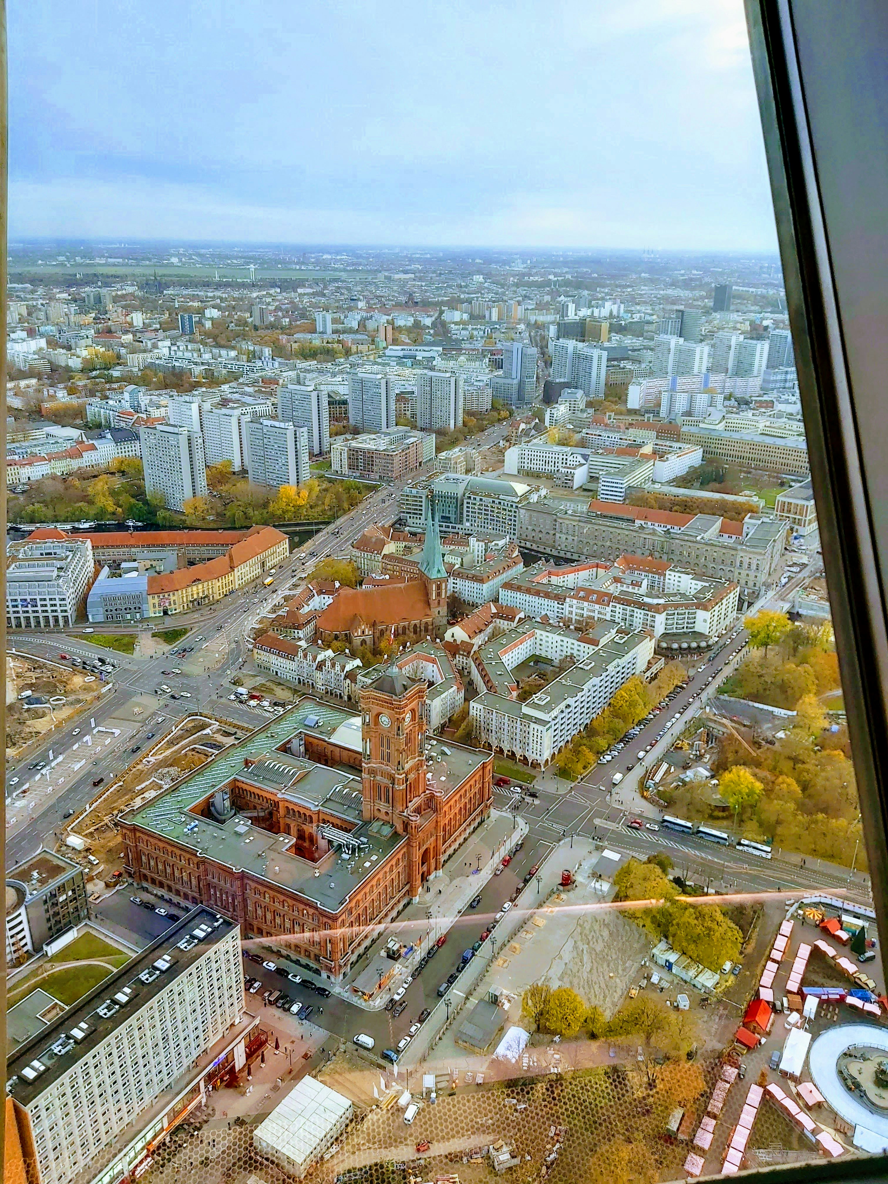 Red Brick Sentinel Over a City Grid: A Windowed Aerial View