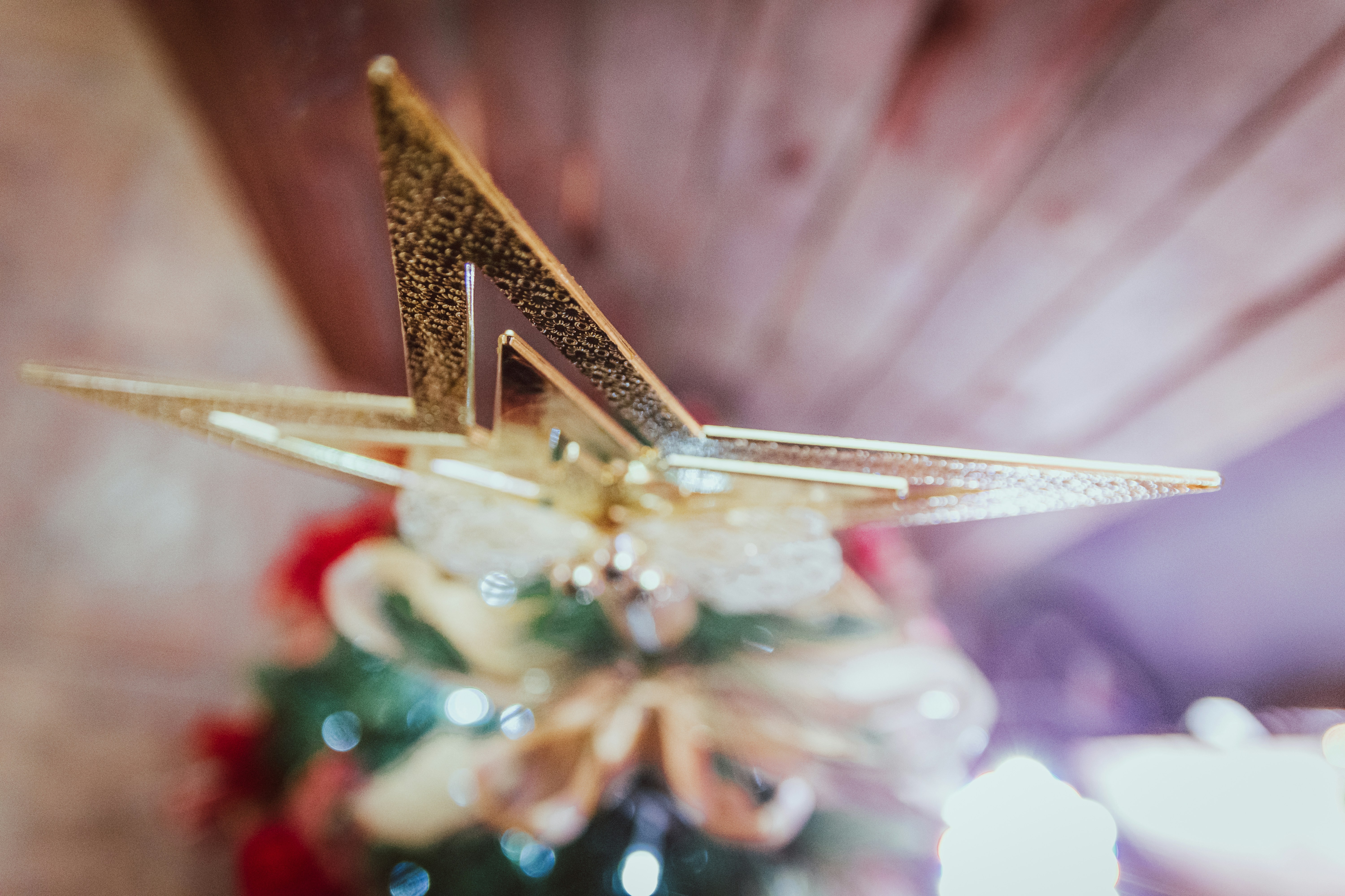 Auric Star Crown: Close-Up on a Christmas Tree Topper in Velvet Bokeh