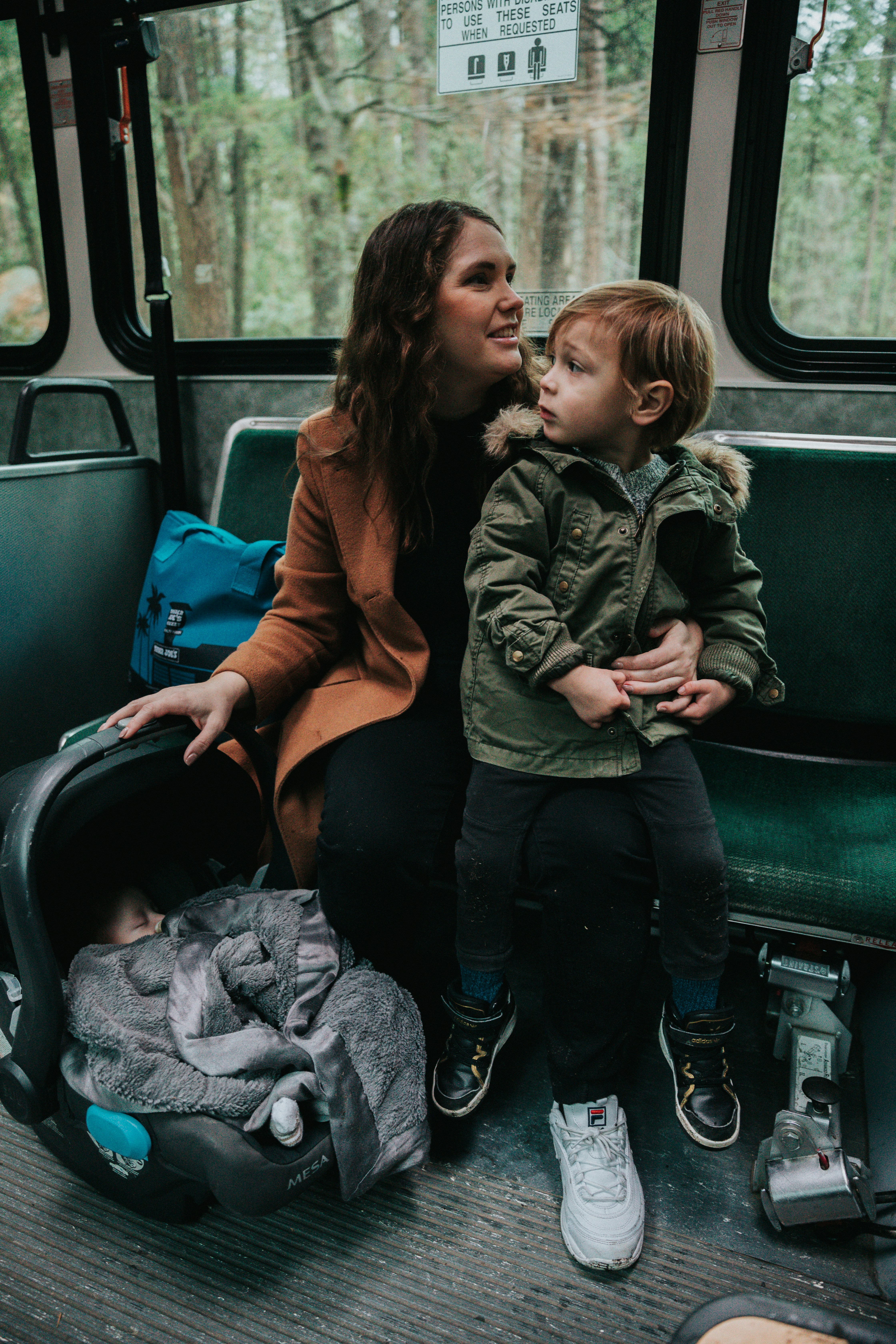 Shallow focus photo of boy sitting on woman's lap photo – Free Human ...