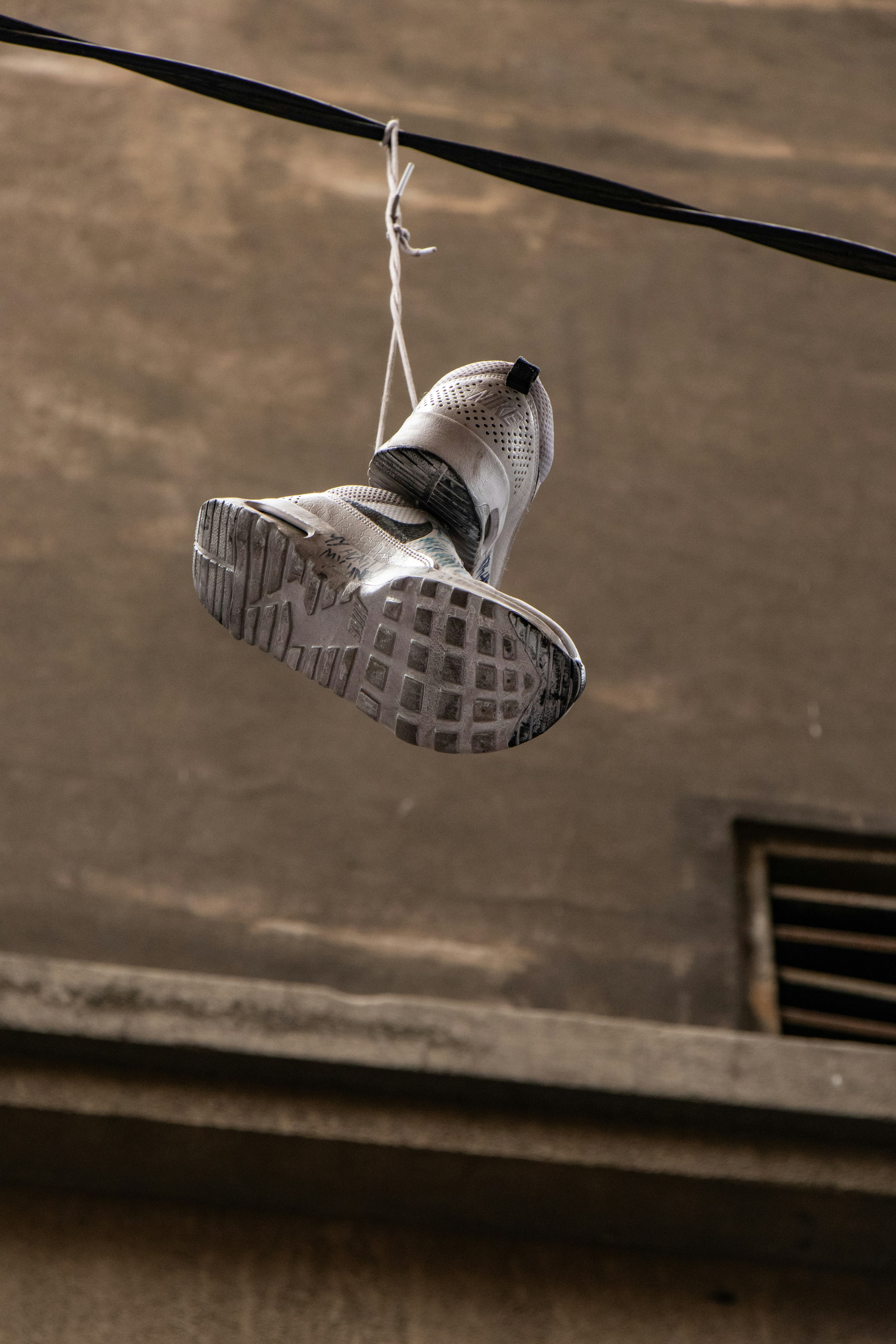 Sole in Suspension: A Quiet Urban Moment