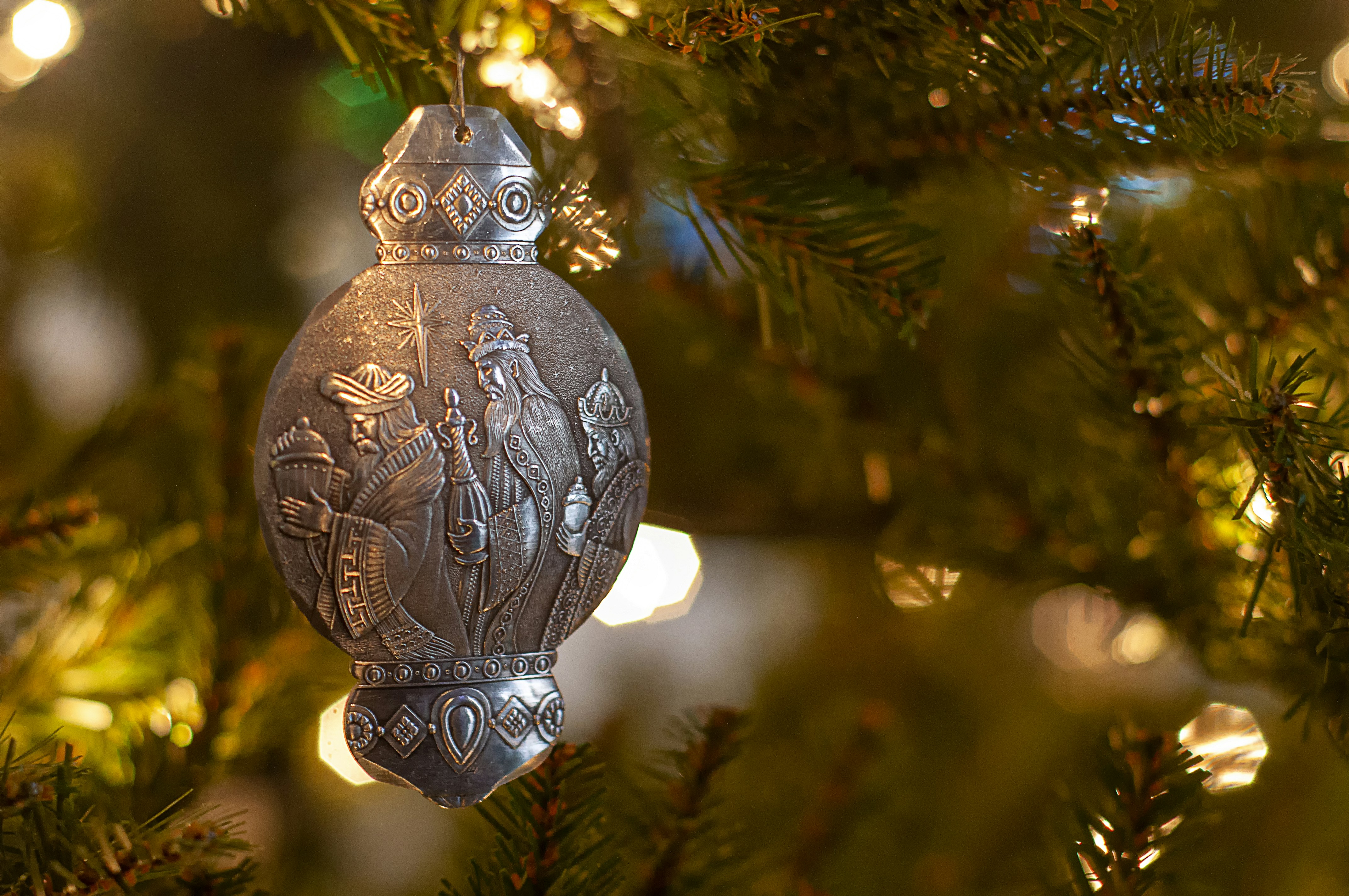Luminous Carved Ornament Suspended in a Warm Christmas Glow