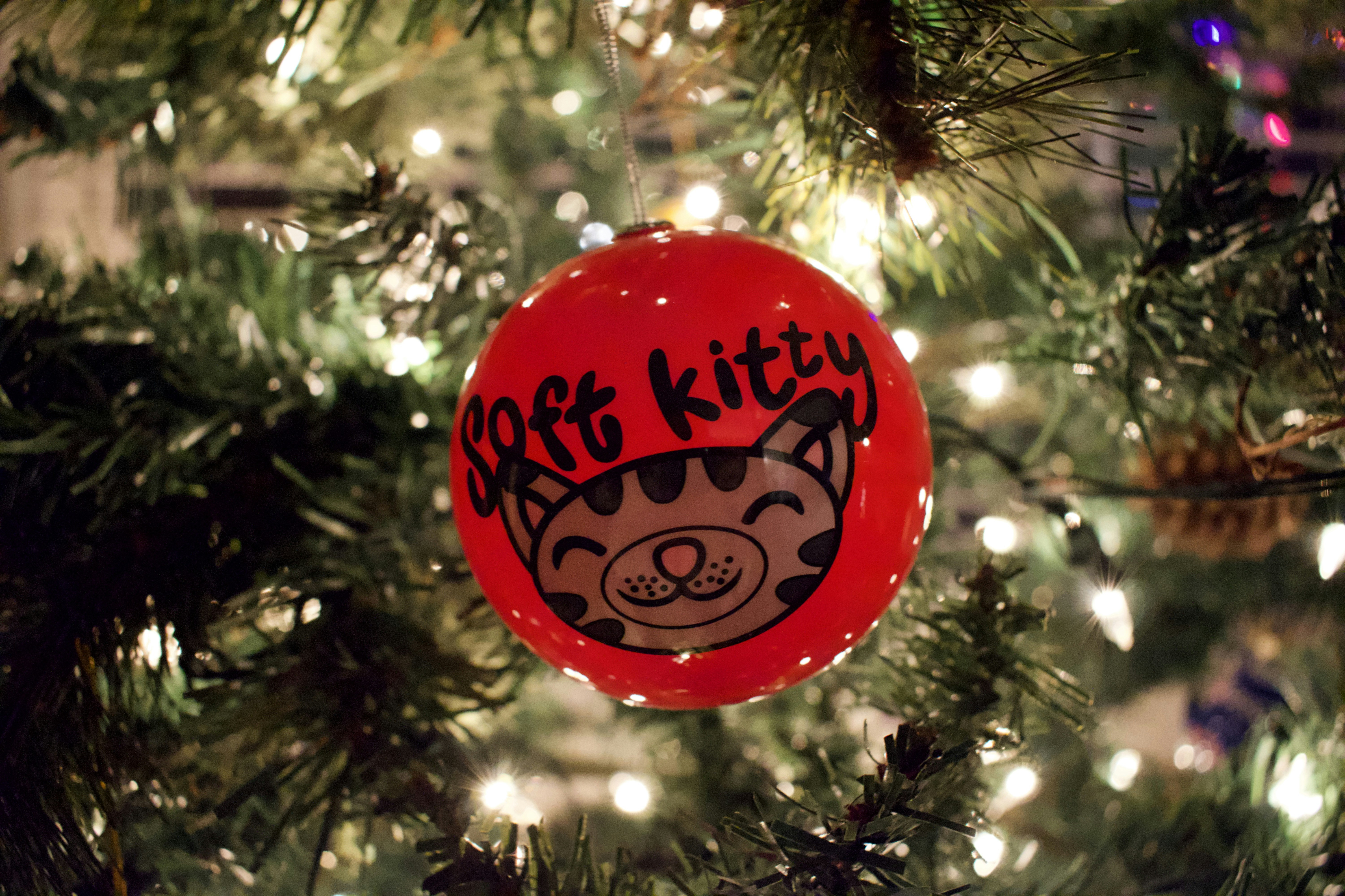 shallow focus photo of red and gray soft kitty-printed Christmas bauble