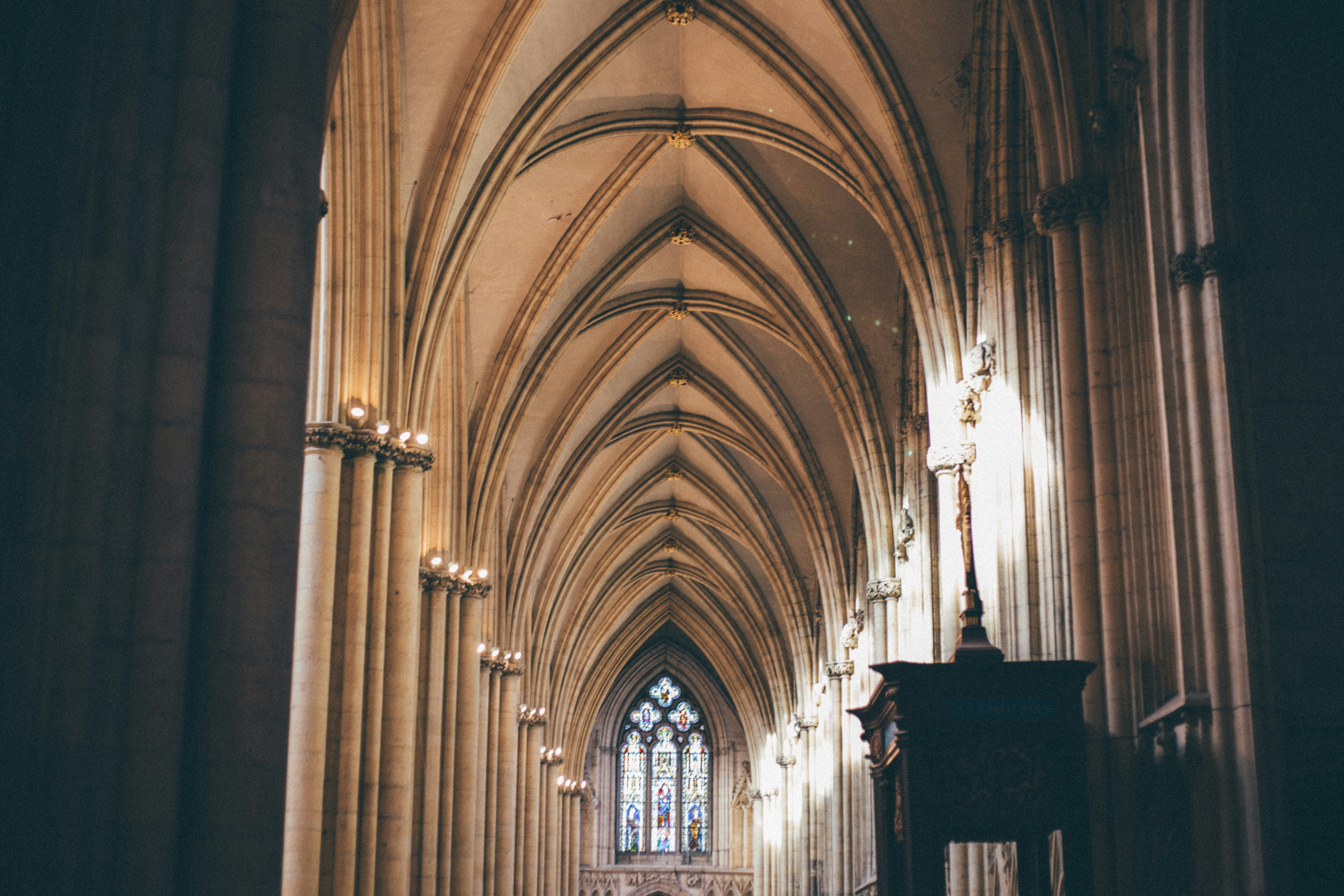 Gothic cathedral interior with soaring arches and ambient lighting casting soft shadows.