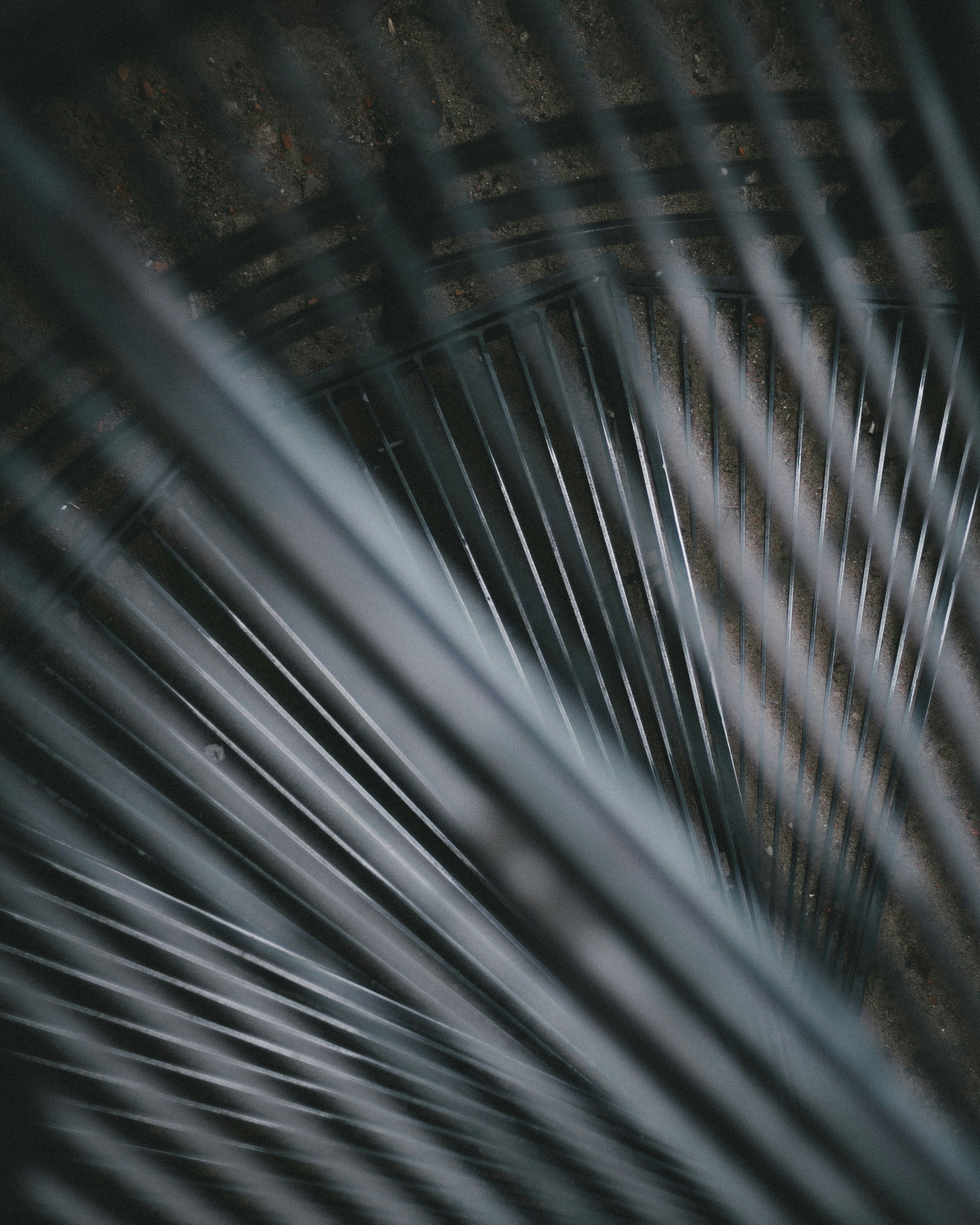 Concentric Threads: Close-Up of a Dark Metal Spiral Grate