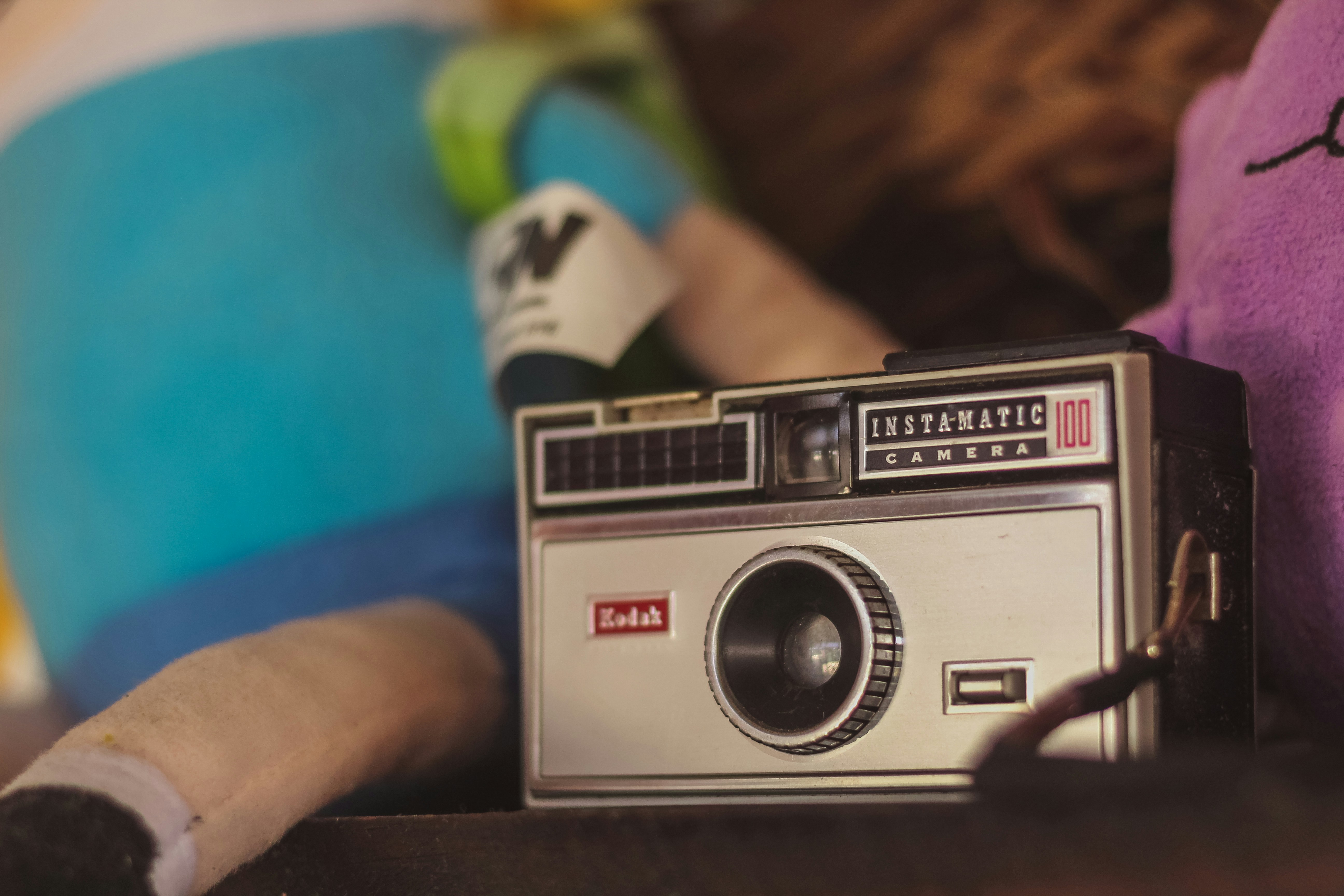 Chrome and Comfort: A Vintage Instamatic Nestled Among Plush