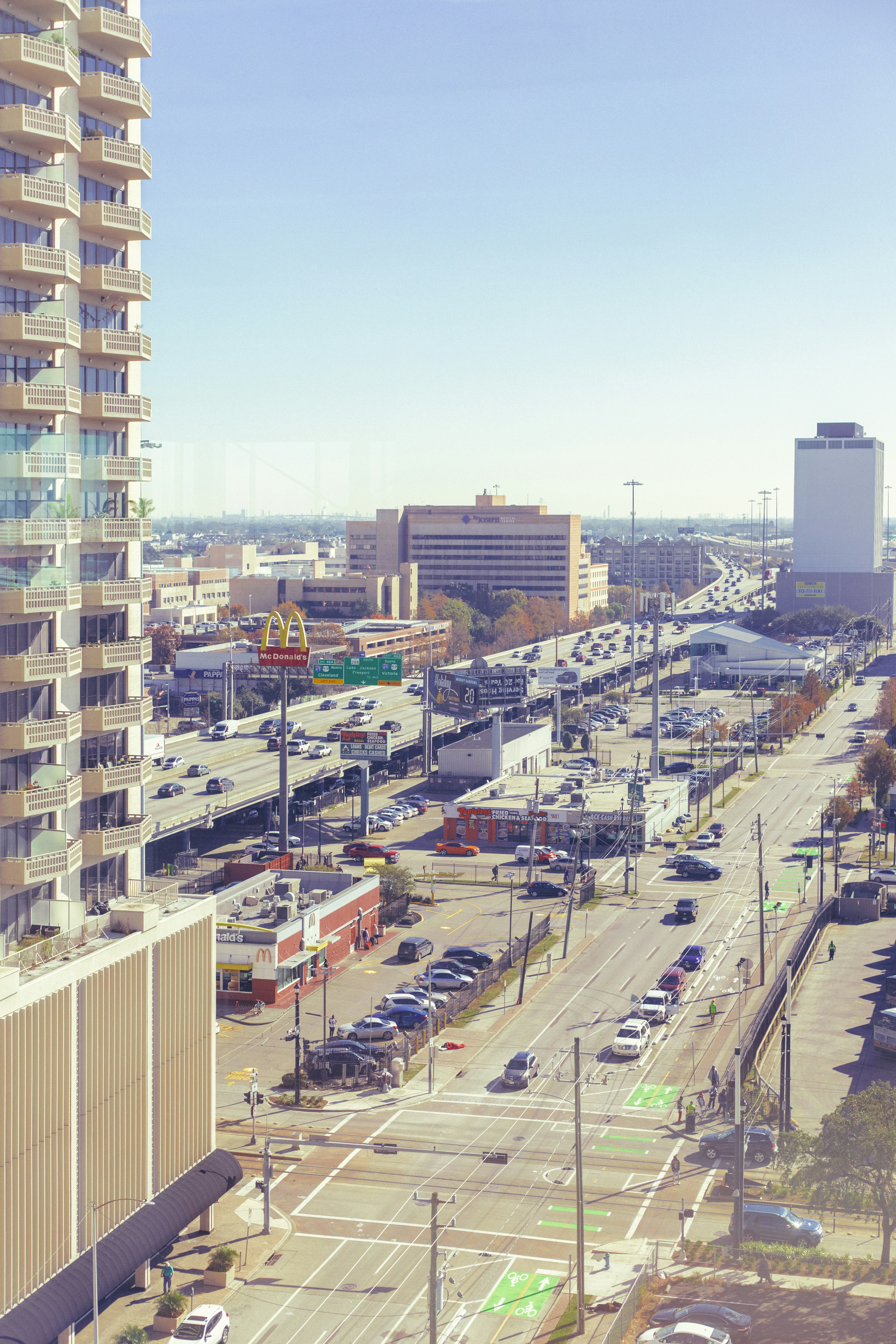 Different vehicles on road viewing high-rise buildings under blue and ...