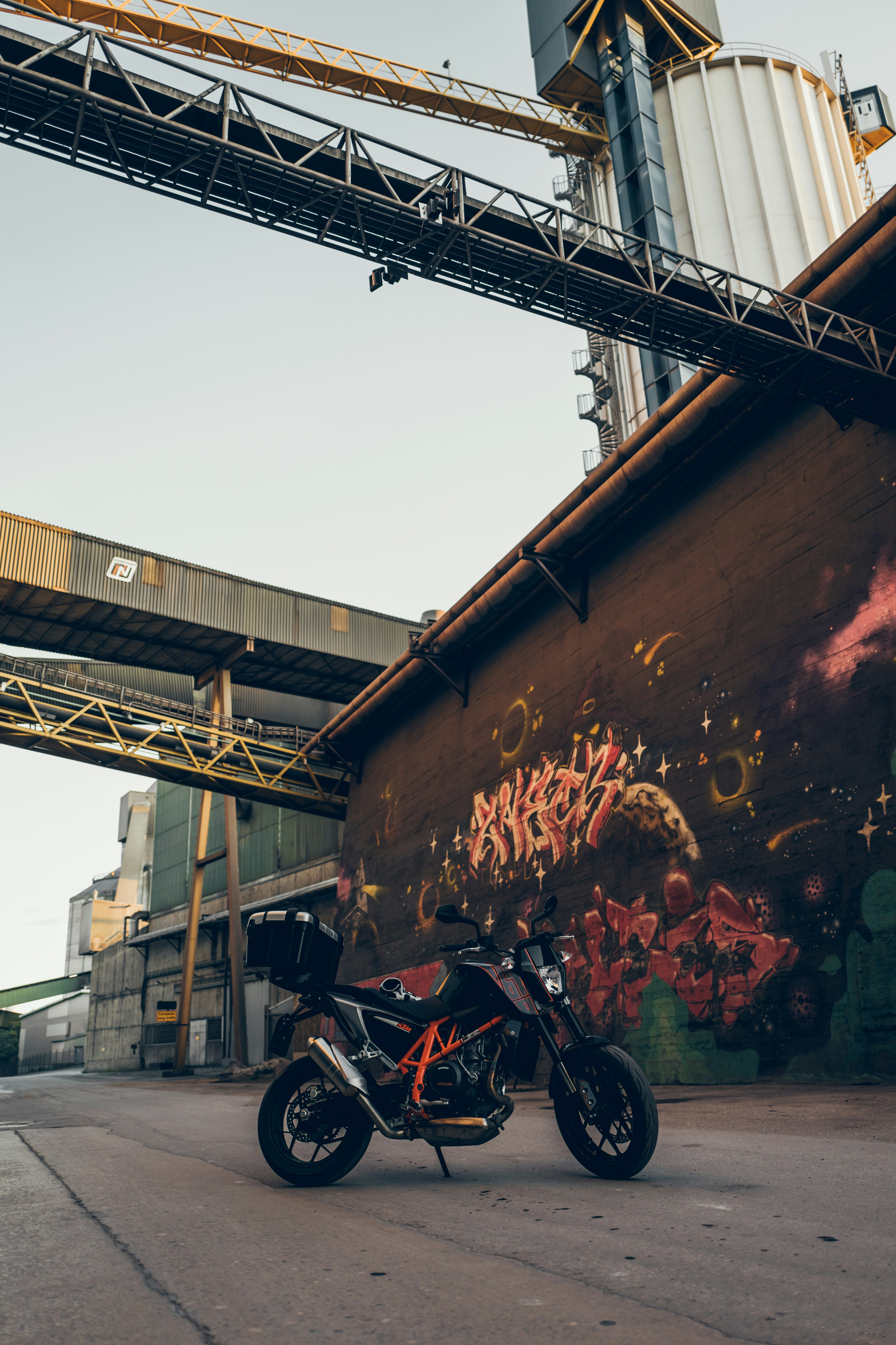 Motorcycle parked near wall with murals photo – Free Building Image on ...