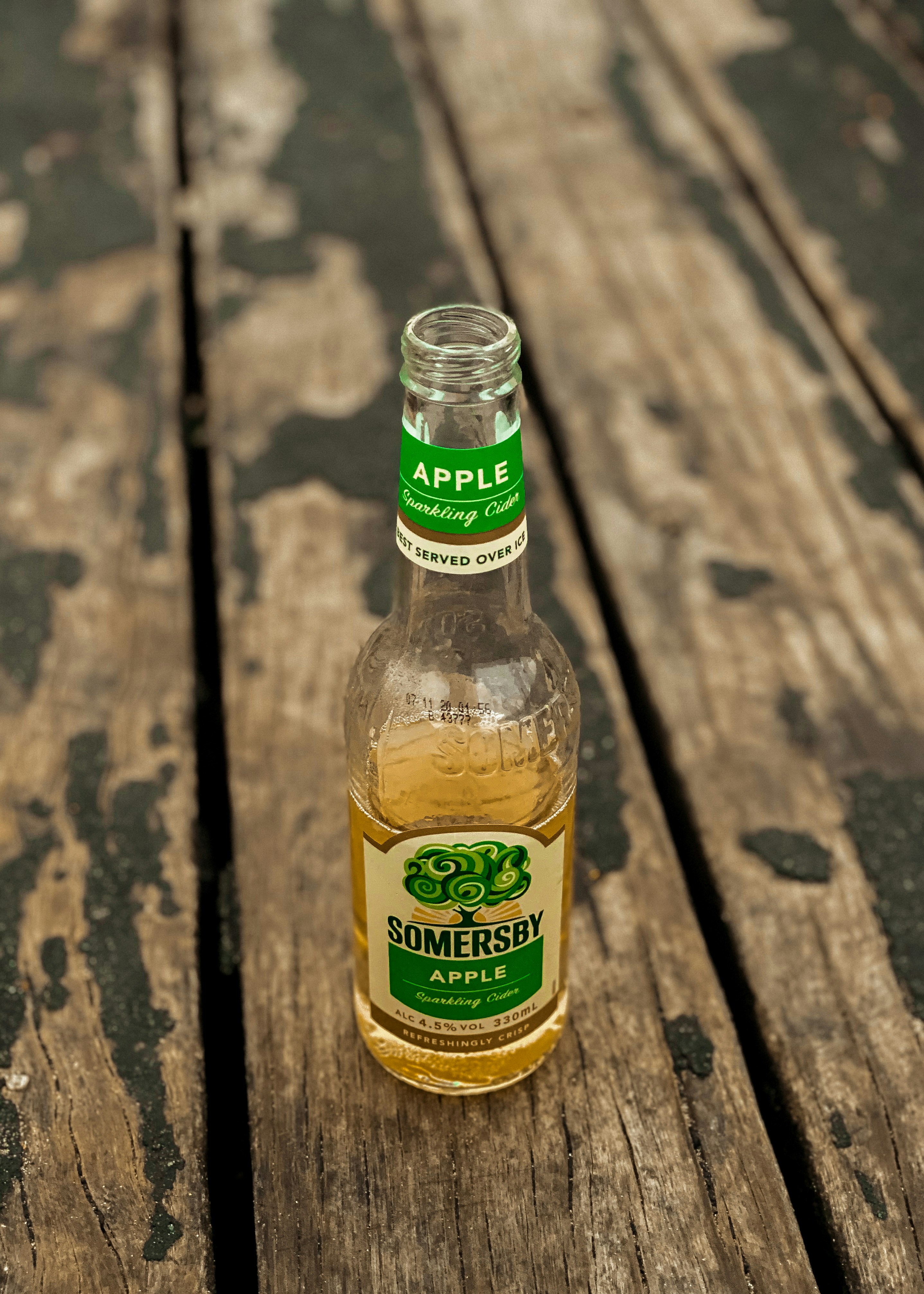 Somersby Apple beverage bottle on wooden surface