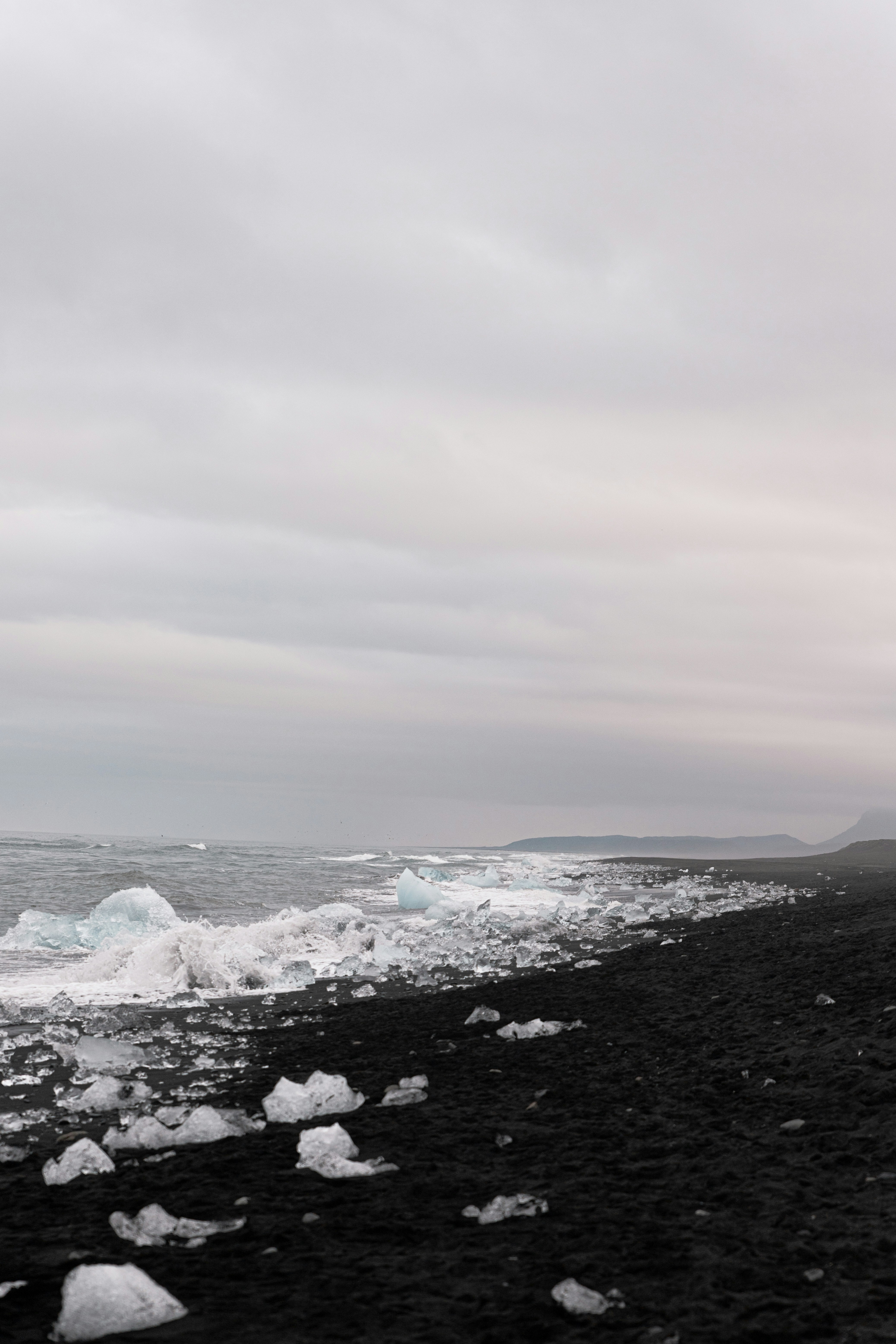 Ice Floes on a Black Sand Beach under a Quiet Arctic Sky