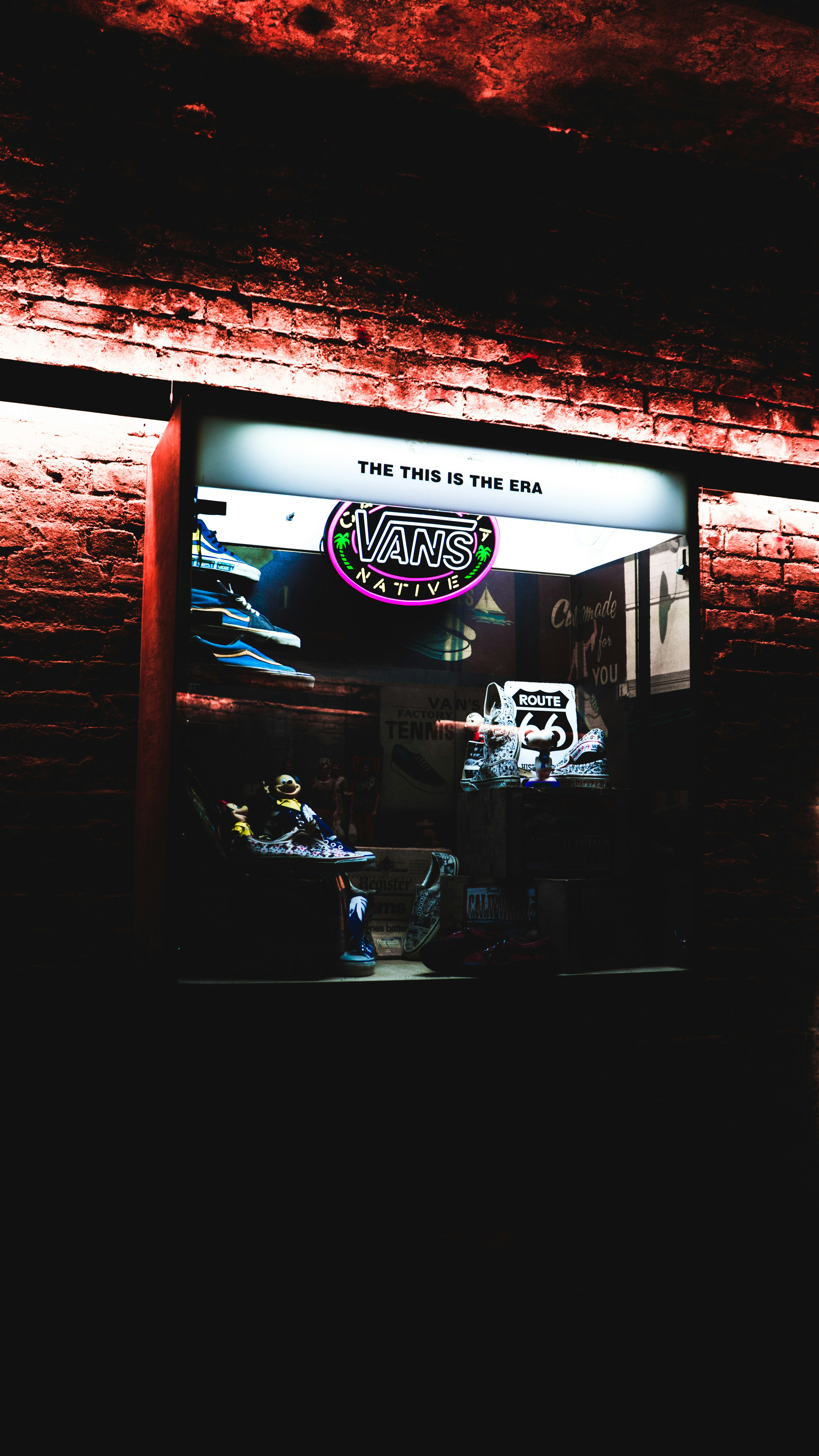 Vans Neon Glow Through Brick: Sneakers in a Night Window Display