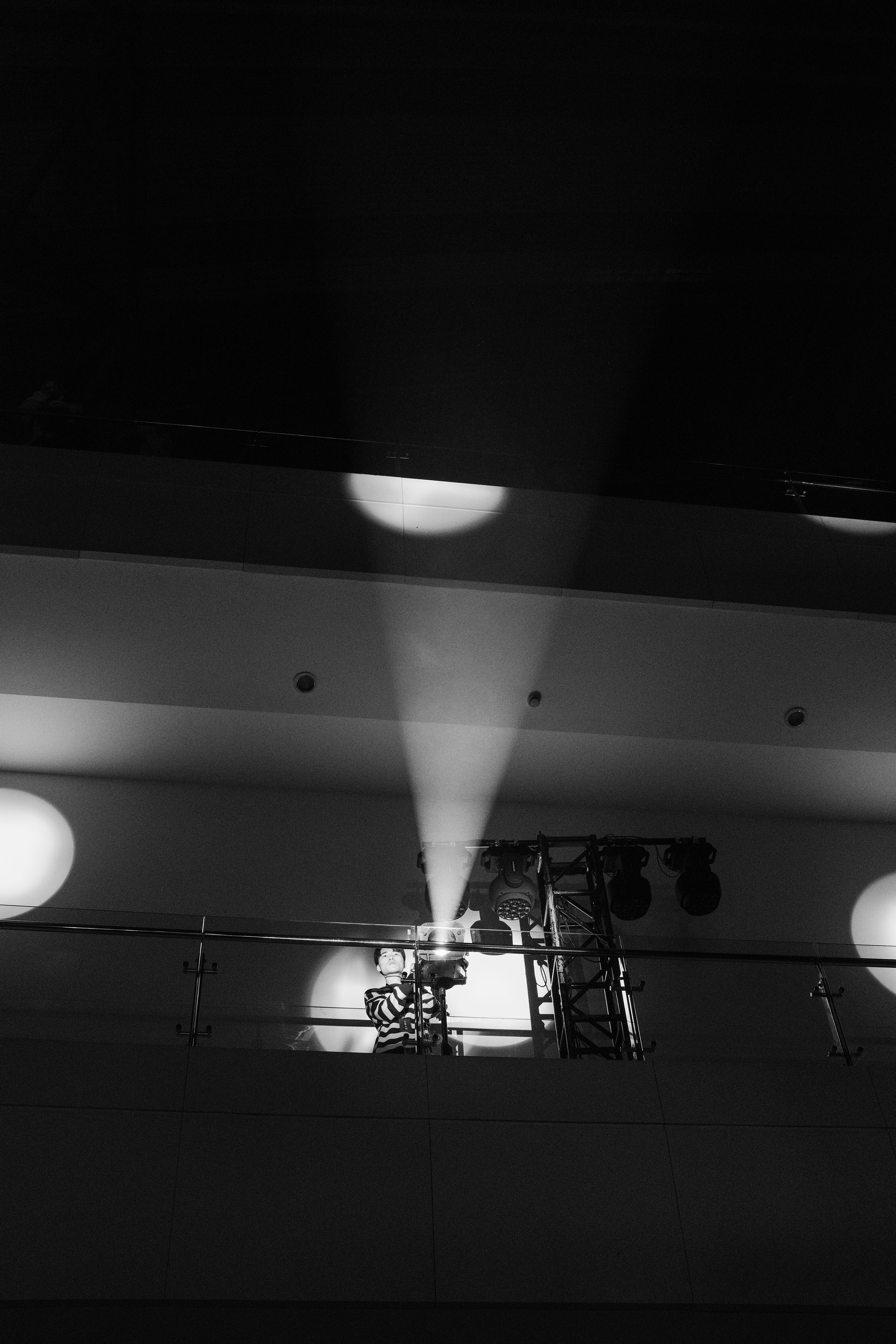 person holding spotlight on balcony