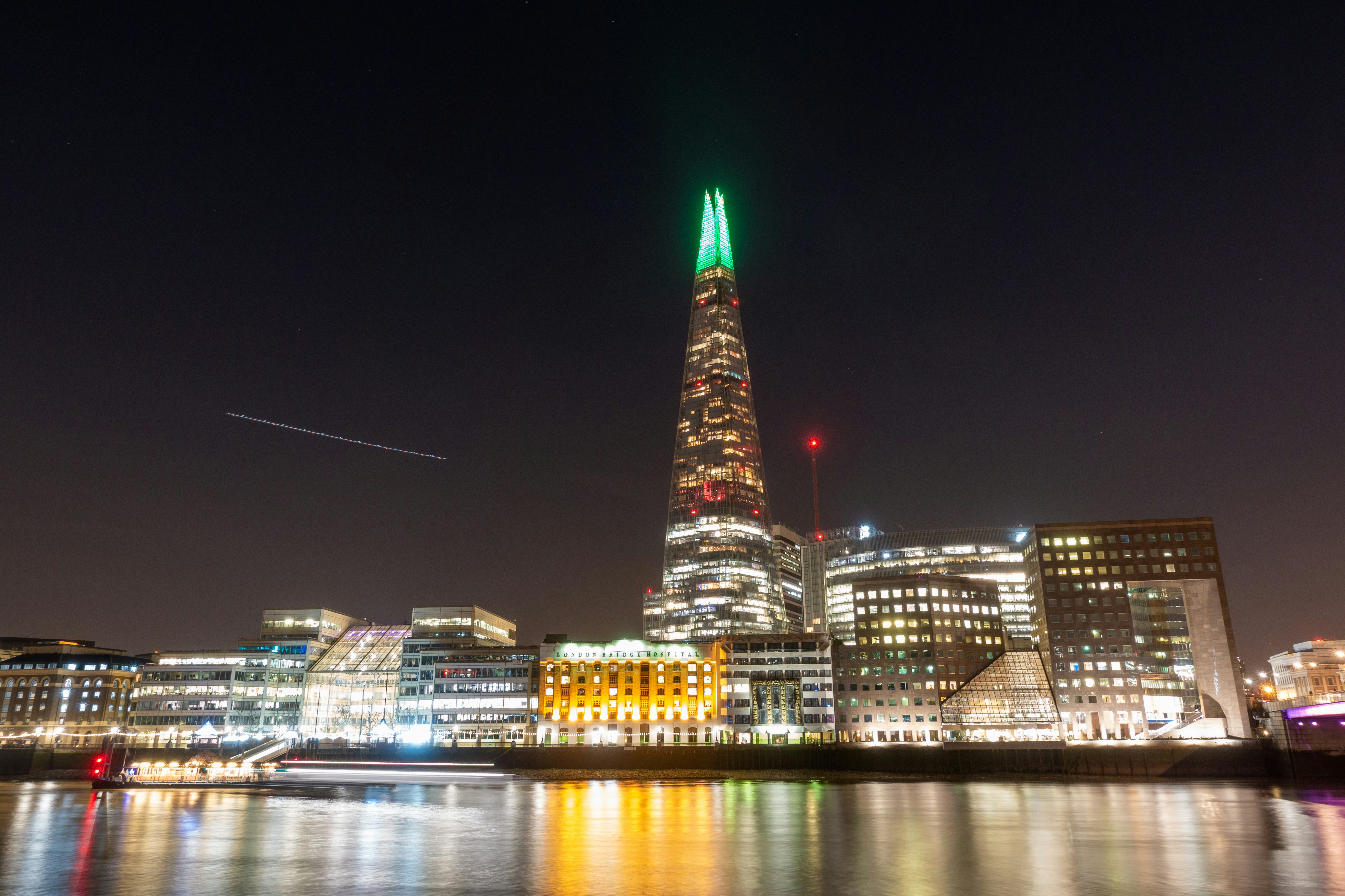 Emerald-tipped Shard crowns London's riverfront at night