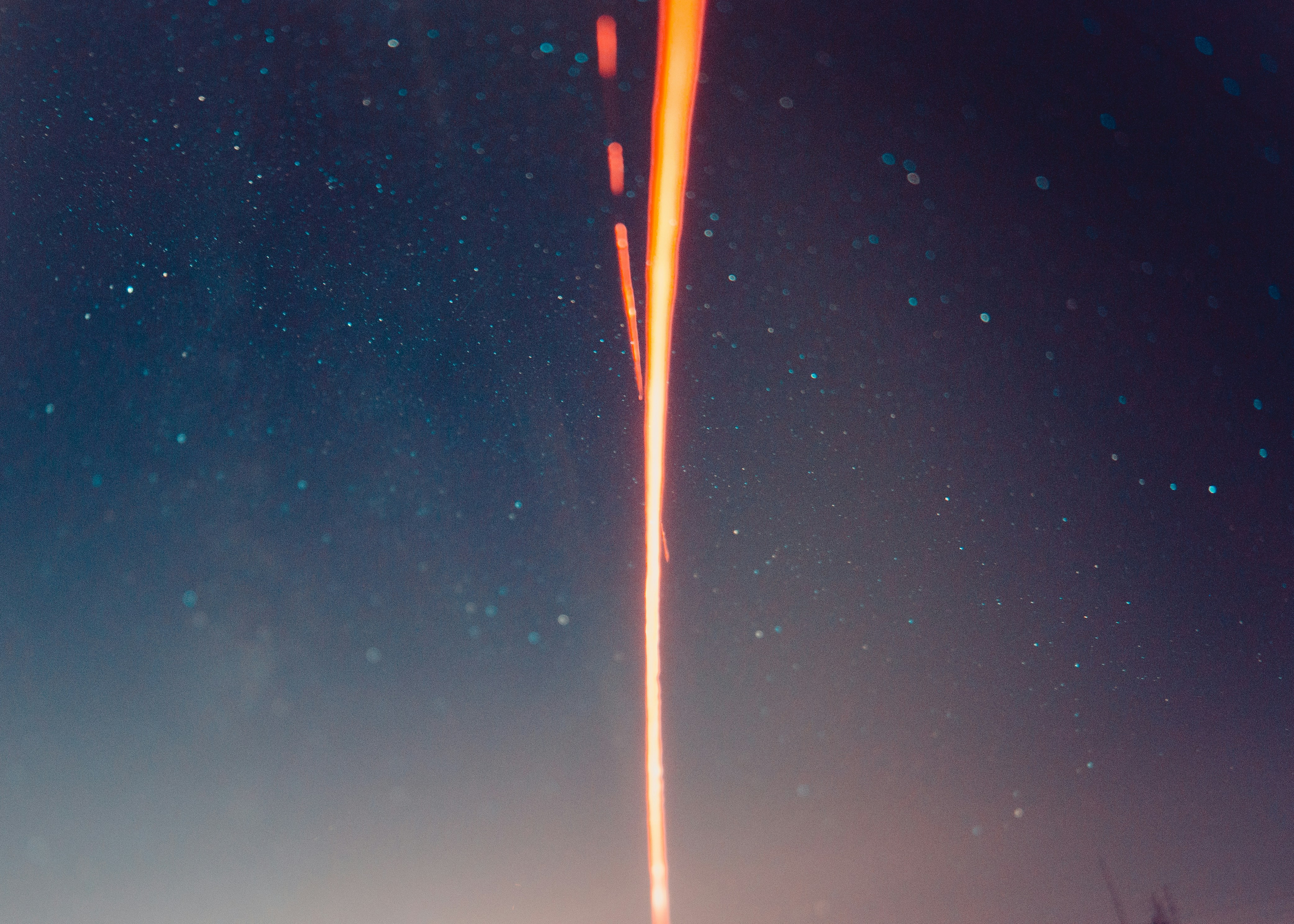 Vertical Fire Trail Through a Velvet Night Sky