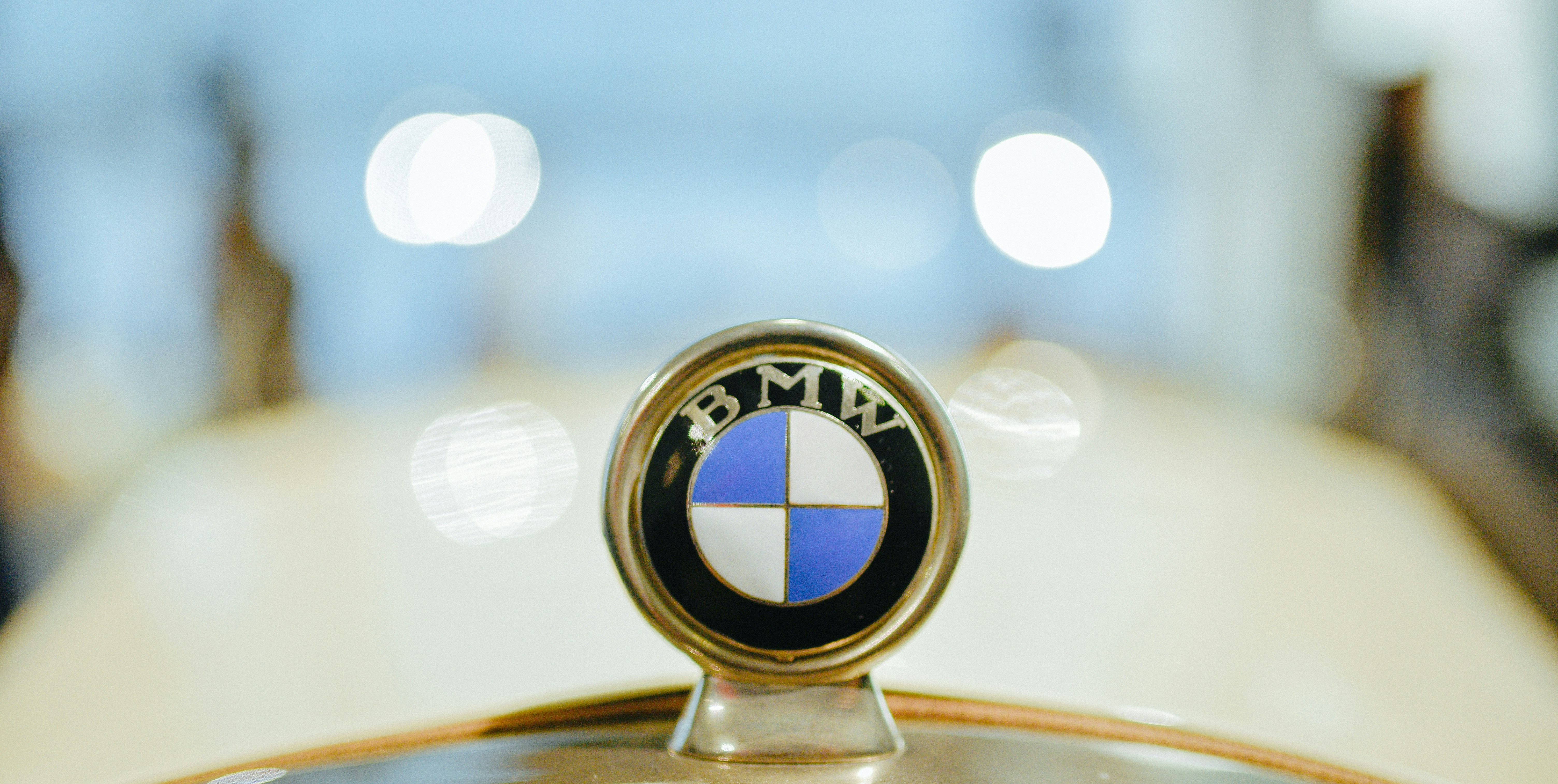Emblem in Focus: Vintage BMW Hood Under Velvet Bokeh