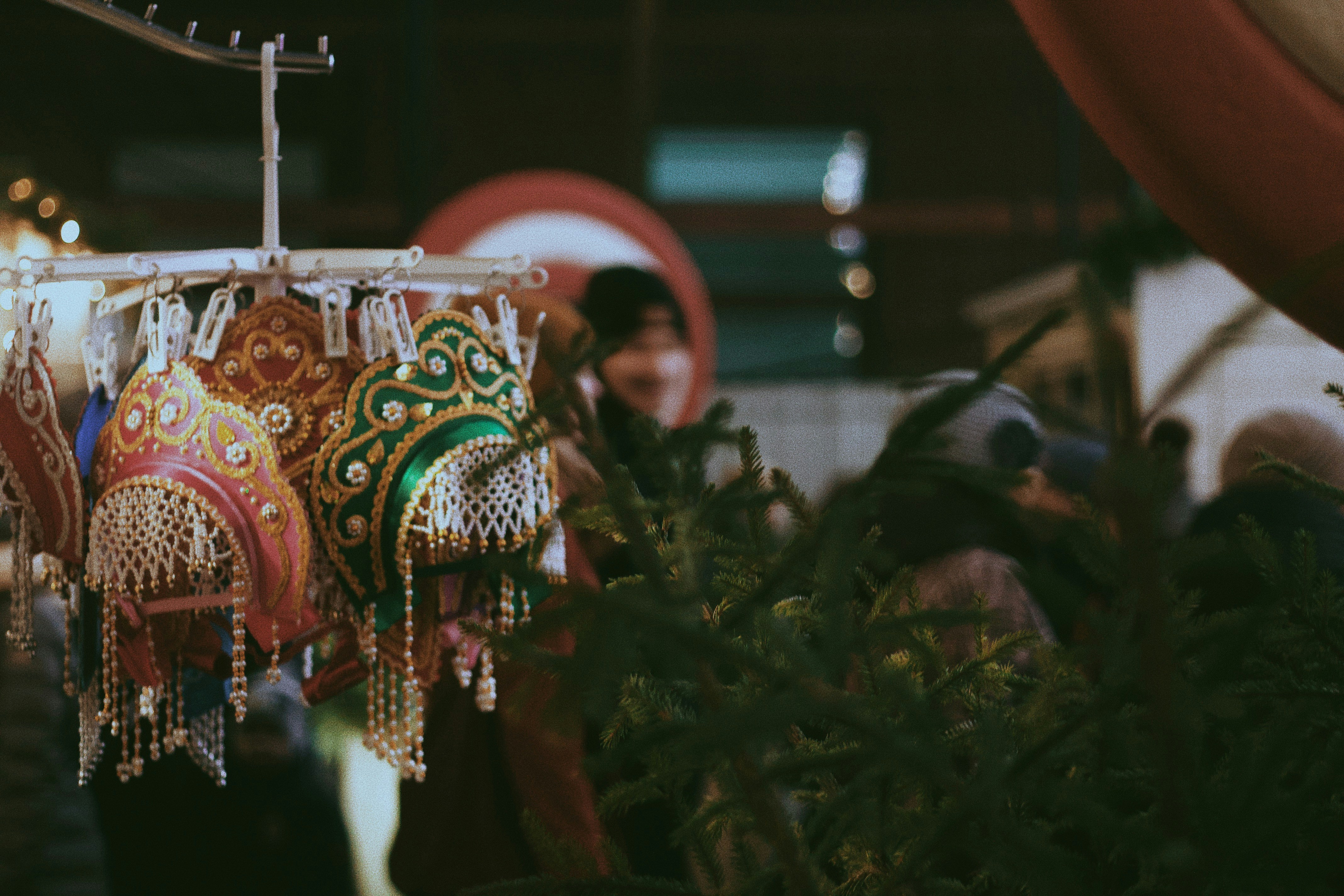 Luminous Beadwork Draped Over a Dim Market Stall
