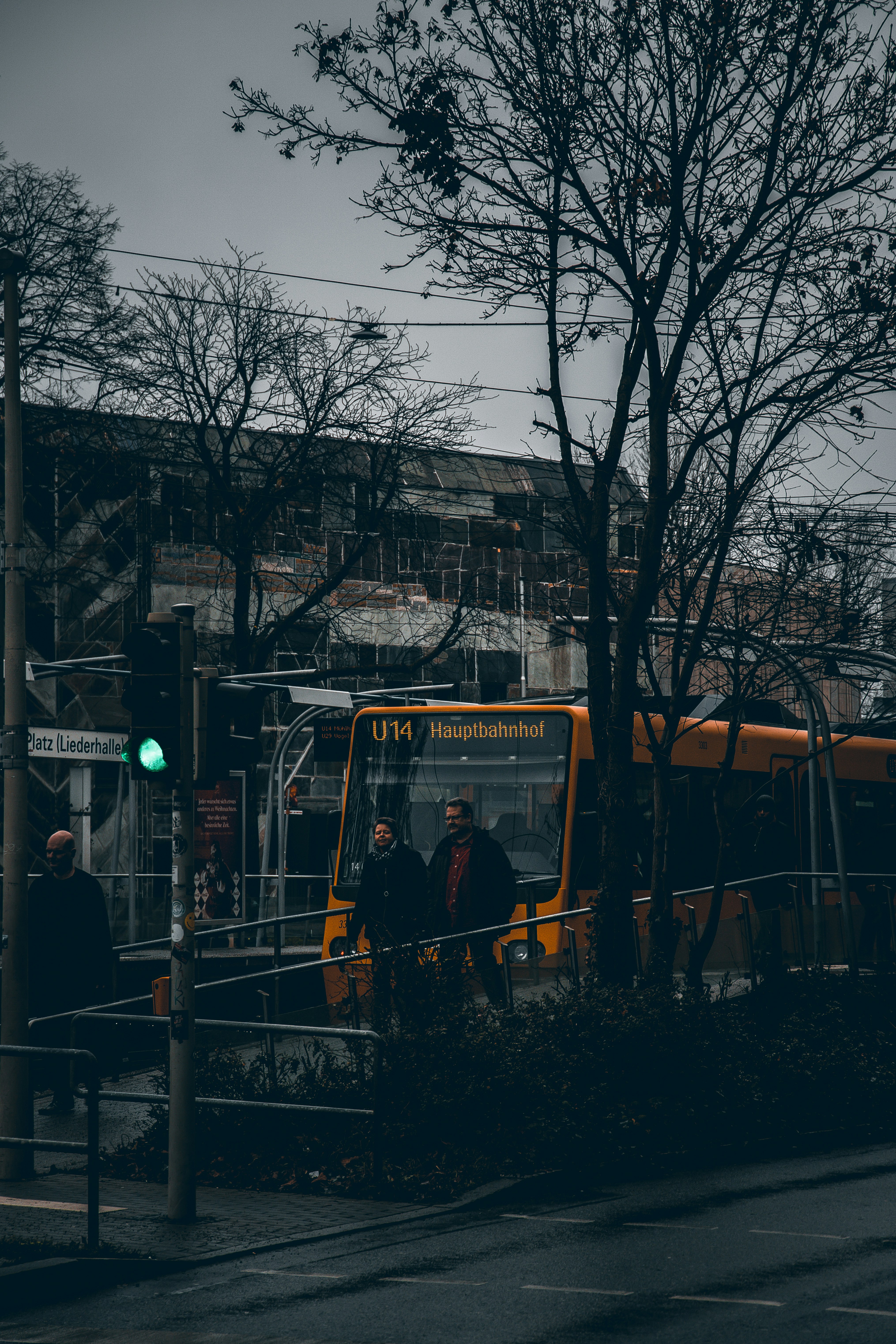 people walking near bus, buildings, and trees during dayMarcel Strauß