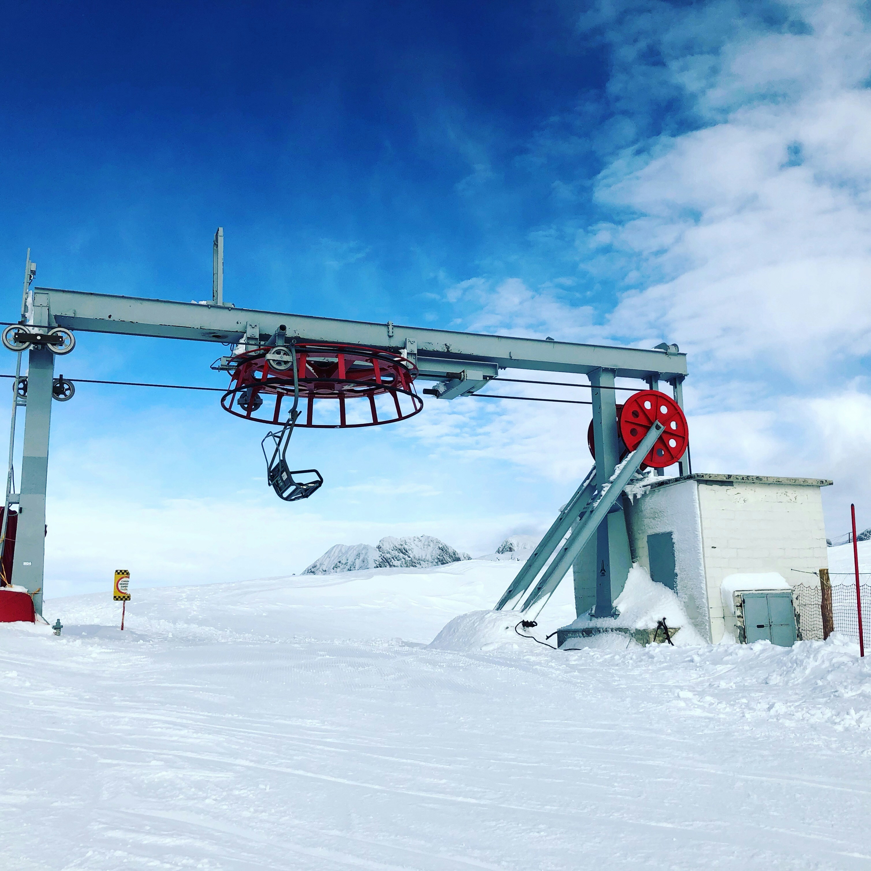 Cerulean Sky, Red Wheel: A Snowbound Chairlift Framing the Frozen Ridge