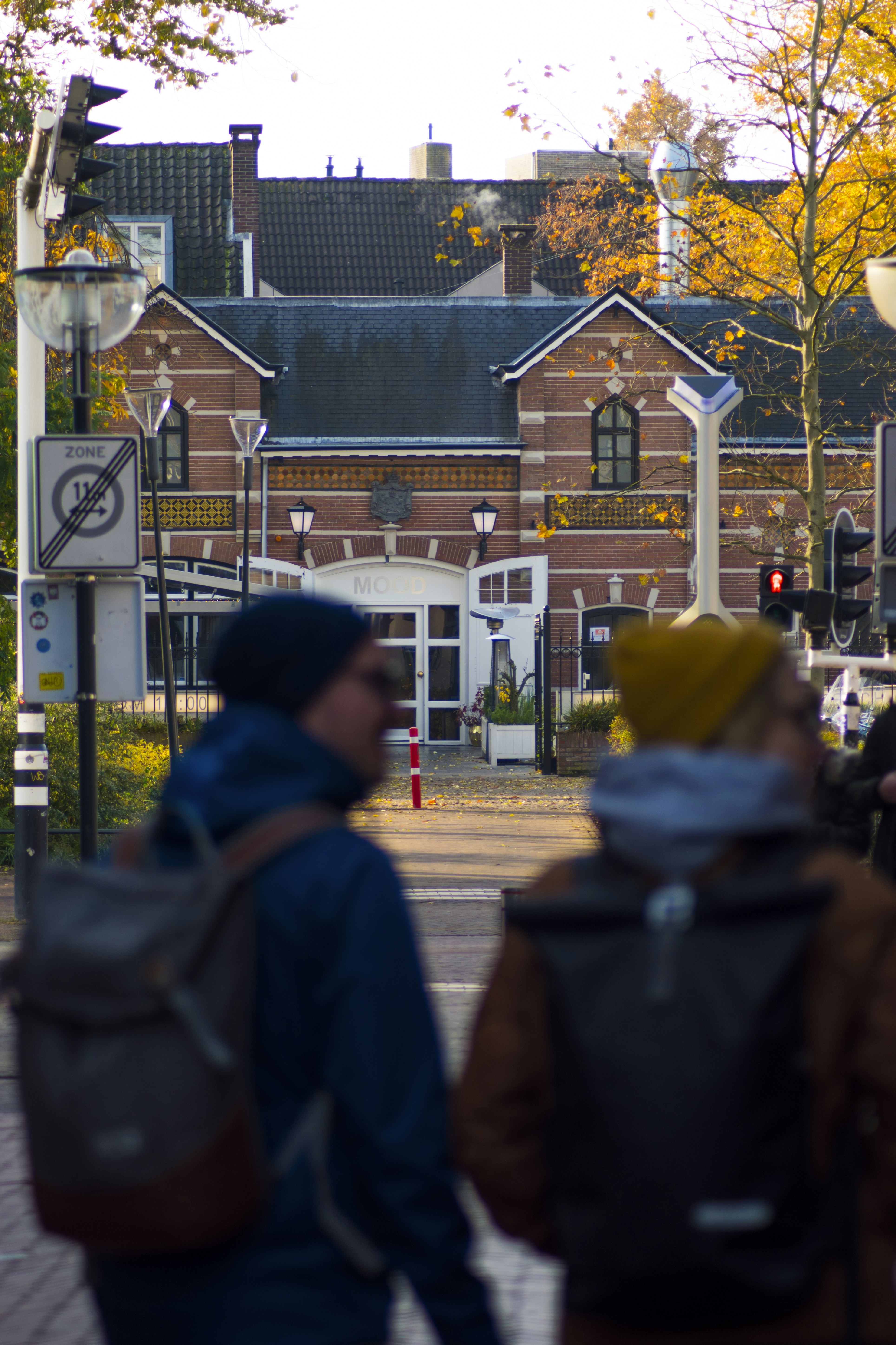 Street Scene with Blurred City Commuters in Front of a Brick Building
