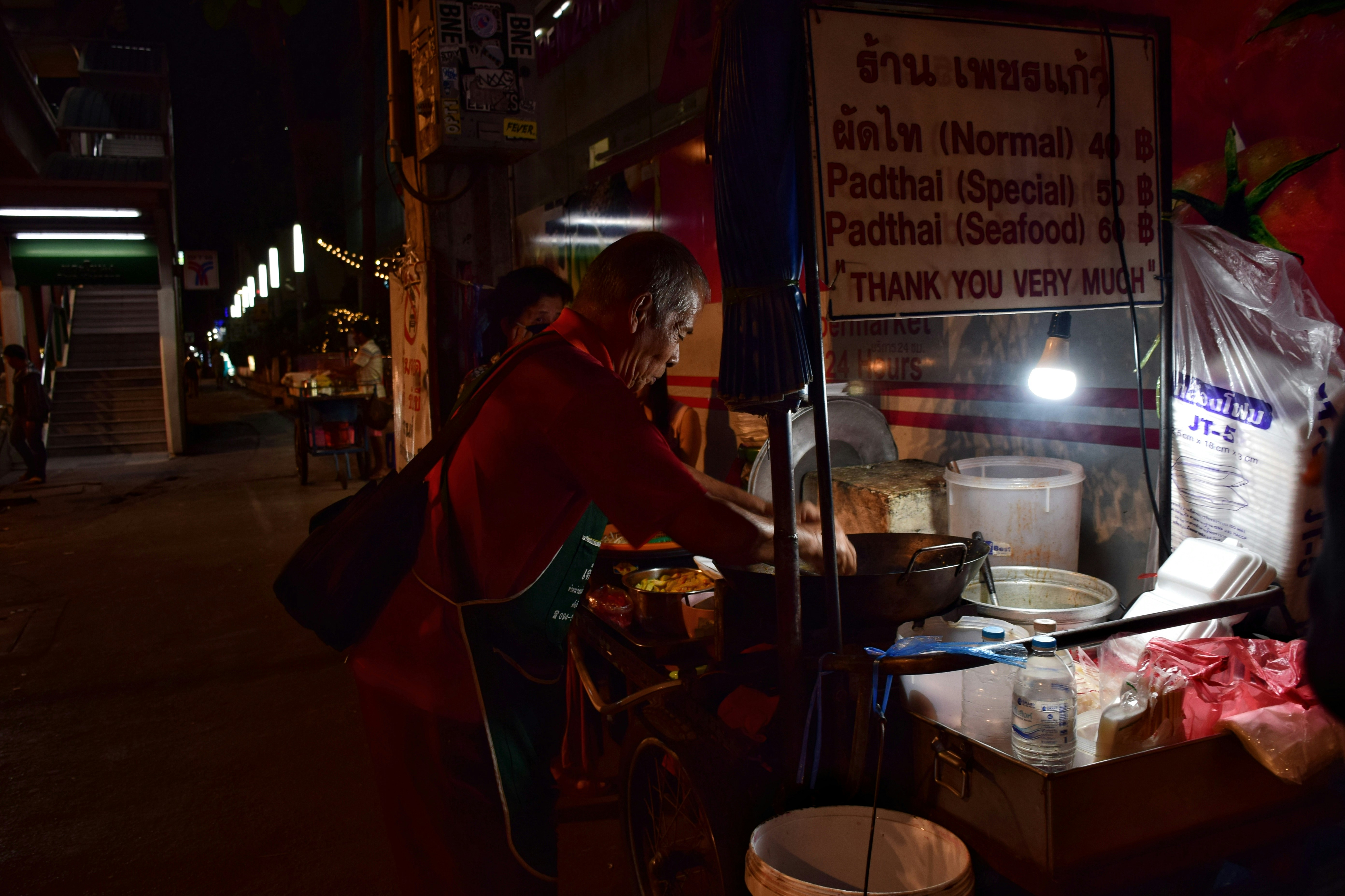 Red Apron in the Firelight: Bangkok Night Market Cook