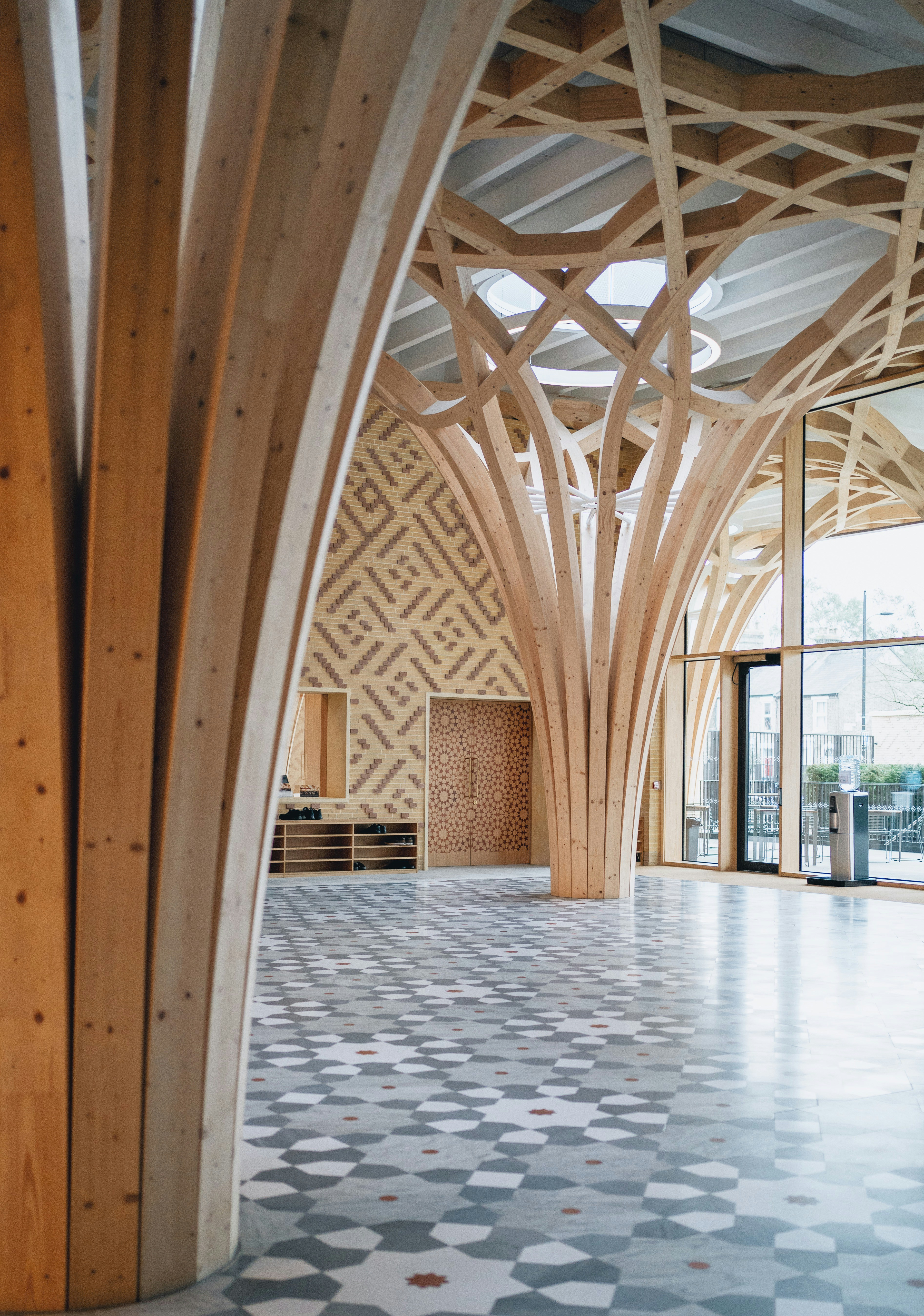 Branching Timber Arches Inside a Modern Pavilion