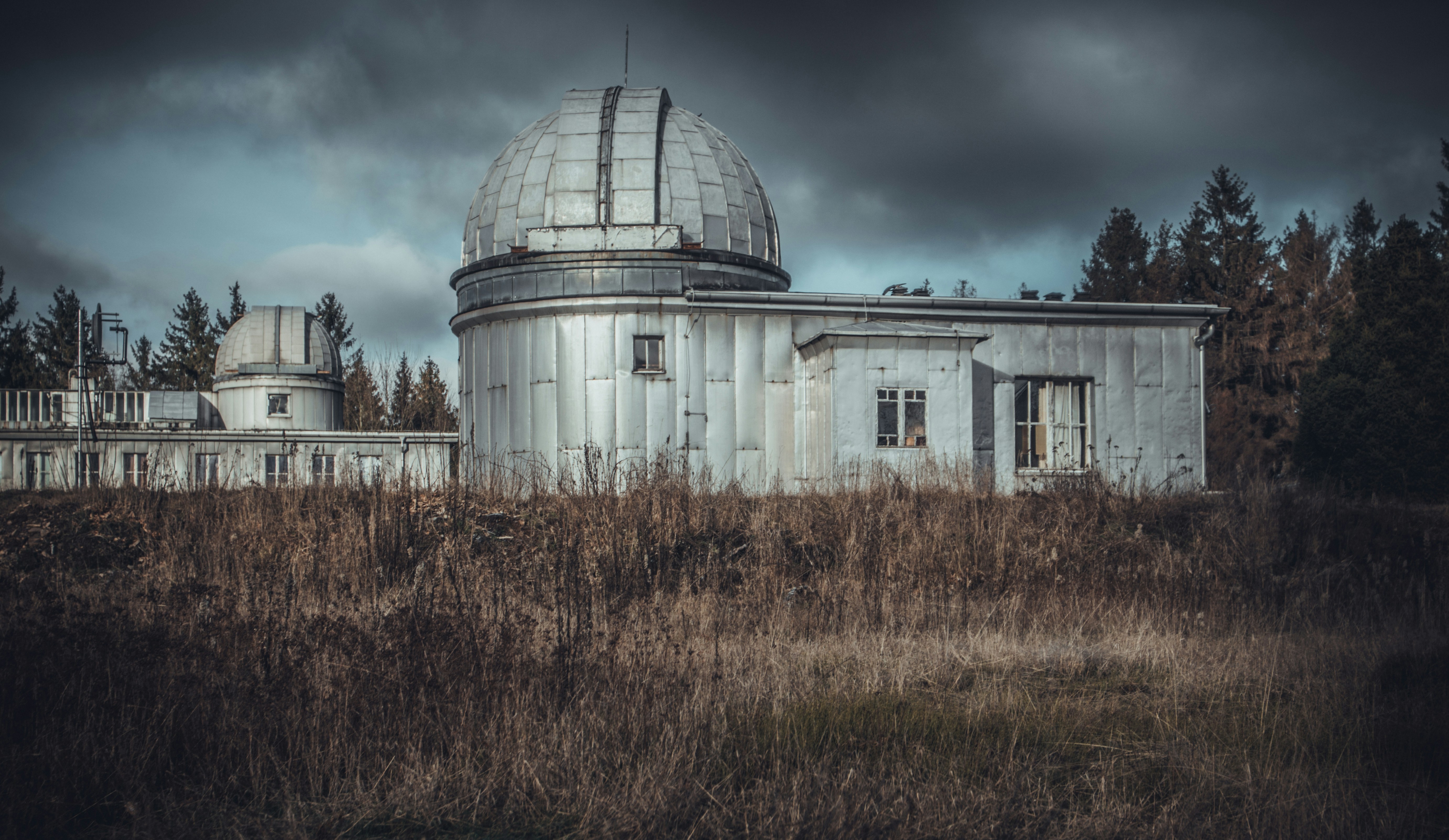 Buildings on grass field during day photo – Free Telescope Image on Unsplash