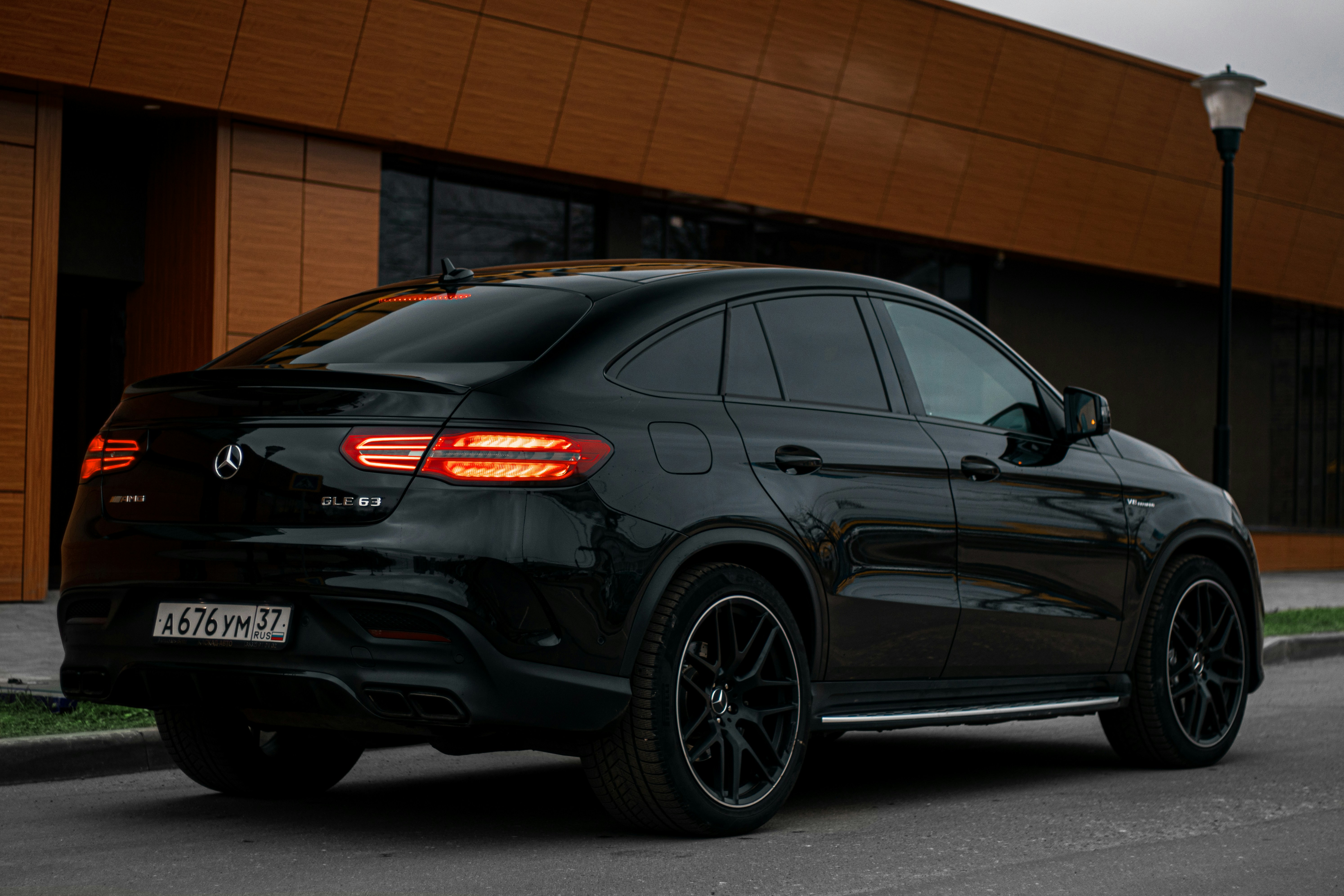 Sleek Black Sedan Against Urban Backdrop