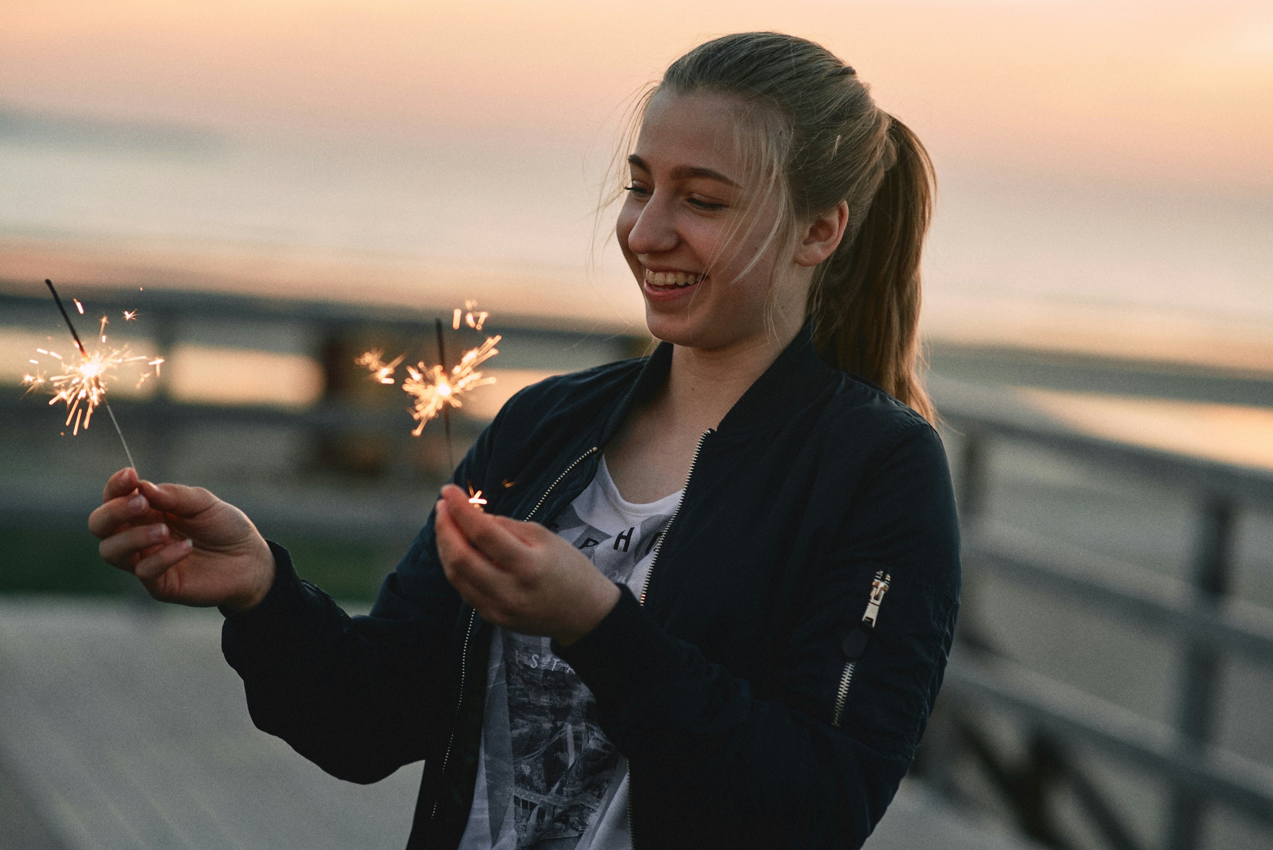 Evening Sparks on the Boardwalk: A Quiet Portrait with Sparkler Light
