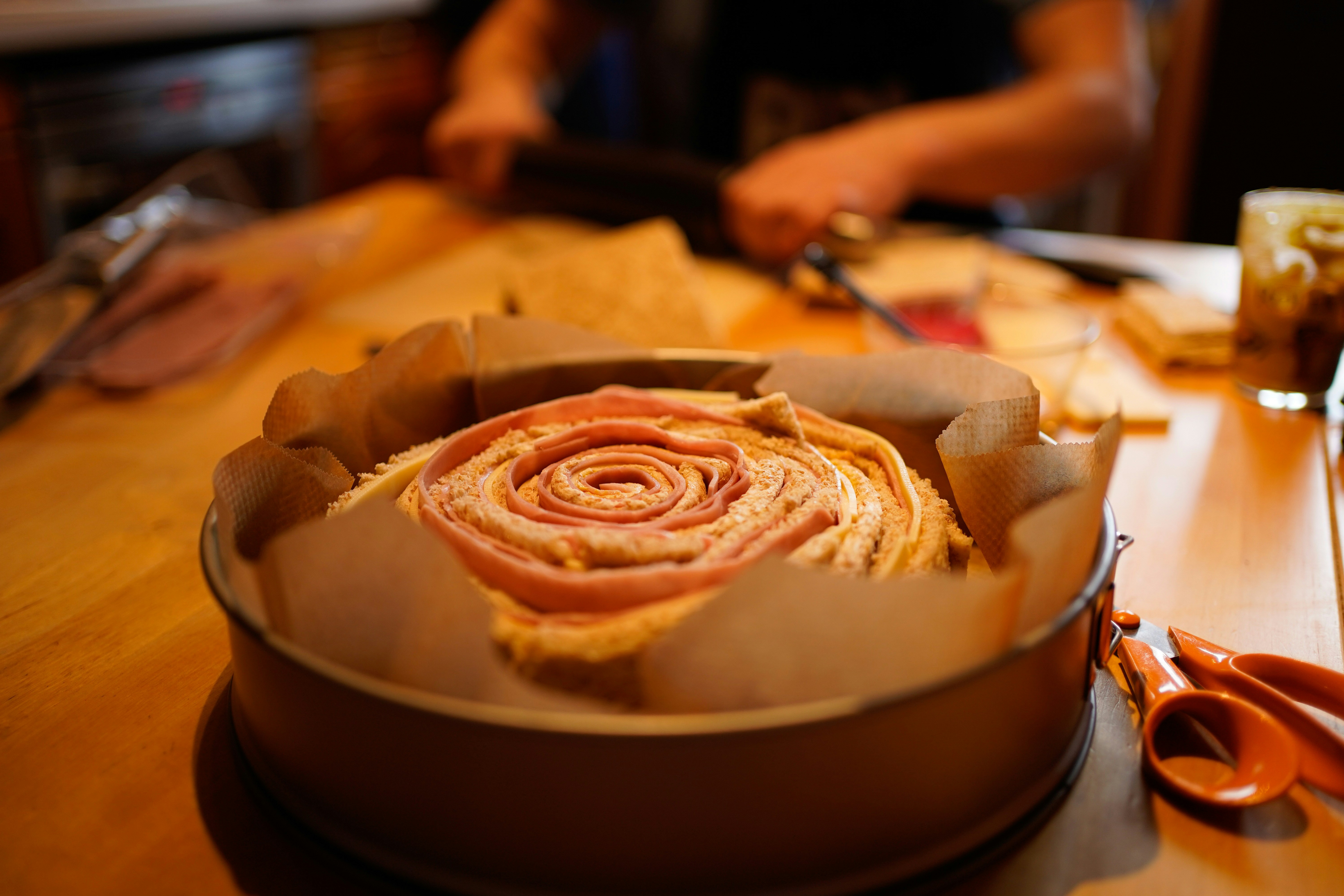 Coiled Ham Pork Crown in a Nonstick Pan on a Wooden Counter