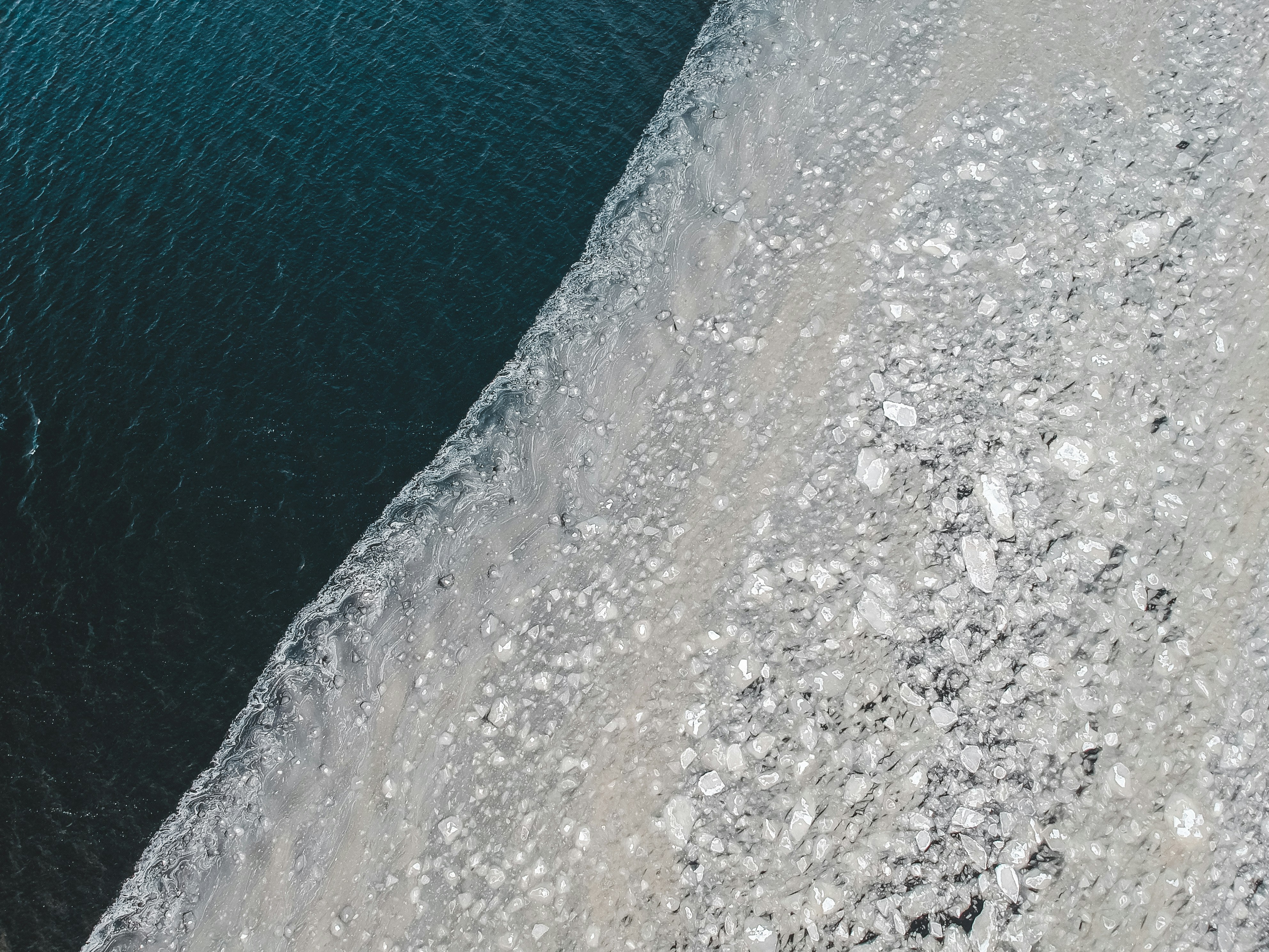 Diagonal Boundary: where dark sea meets pale, rocky shore