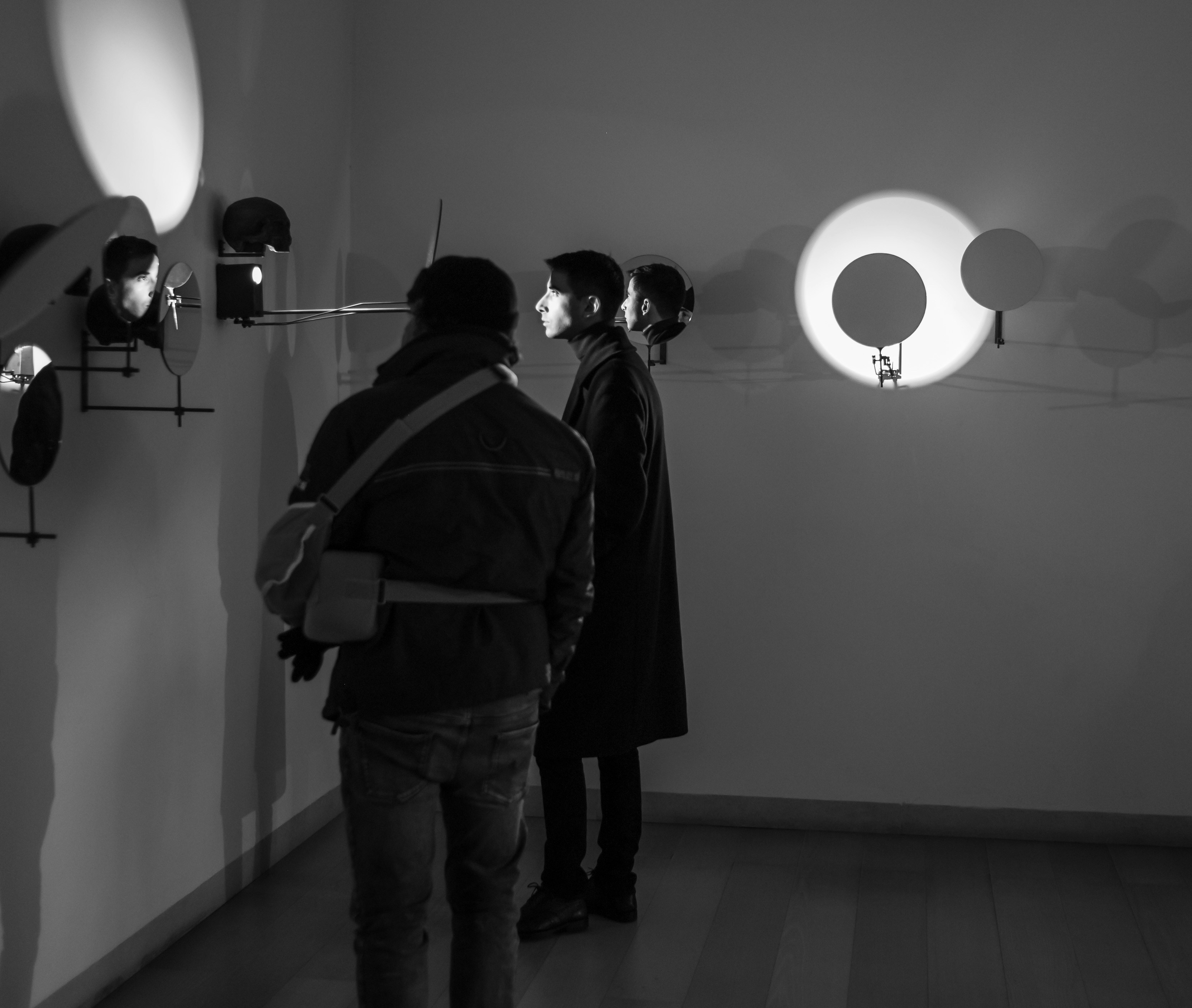 Quiet Gallery Dialogue: Two Visitors in a Ring of Light