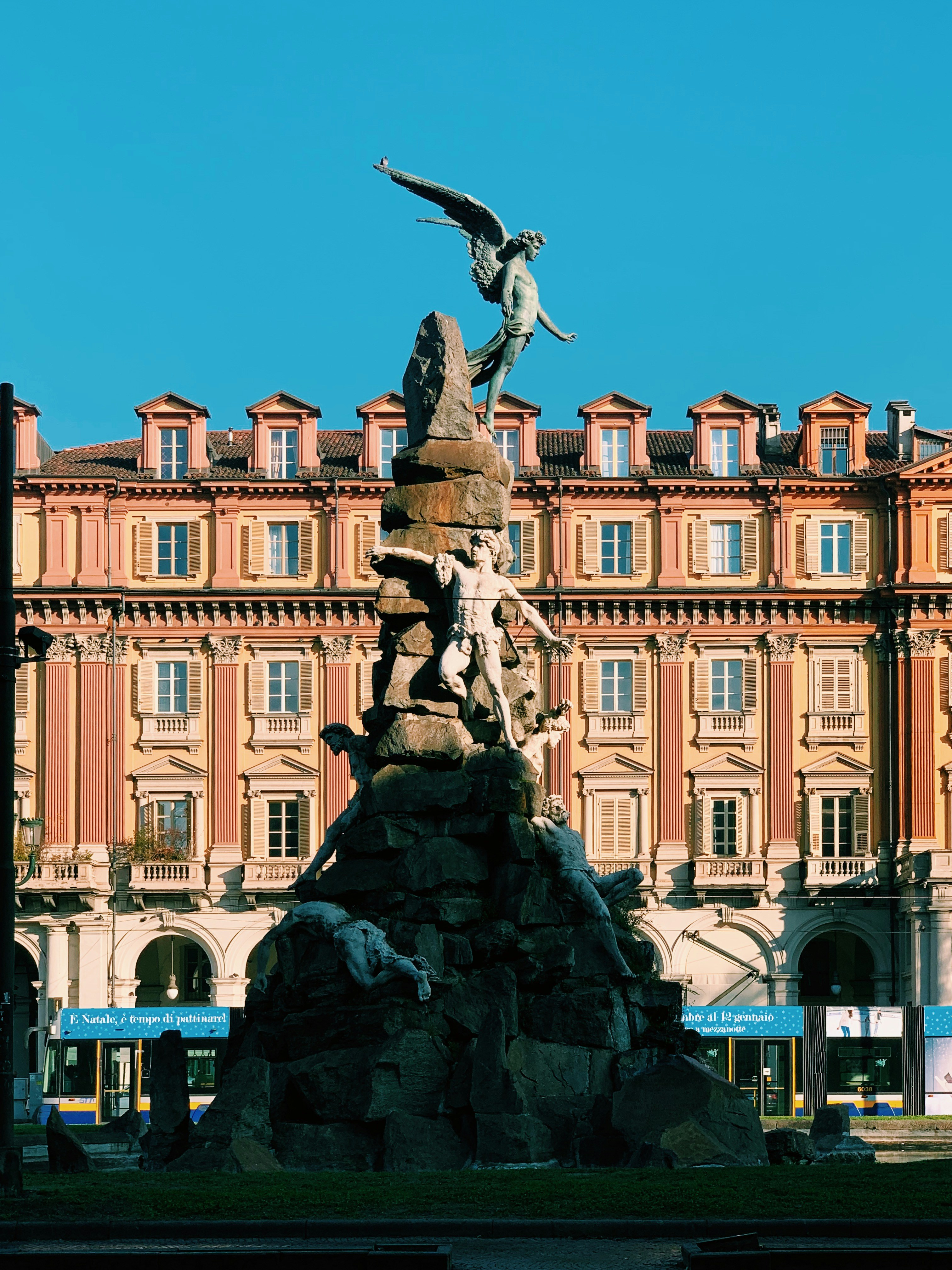 Piazza Statuto, Torino | angel statue in front of brown building