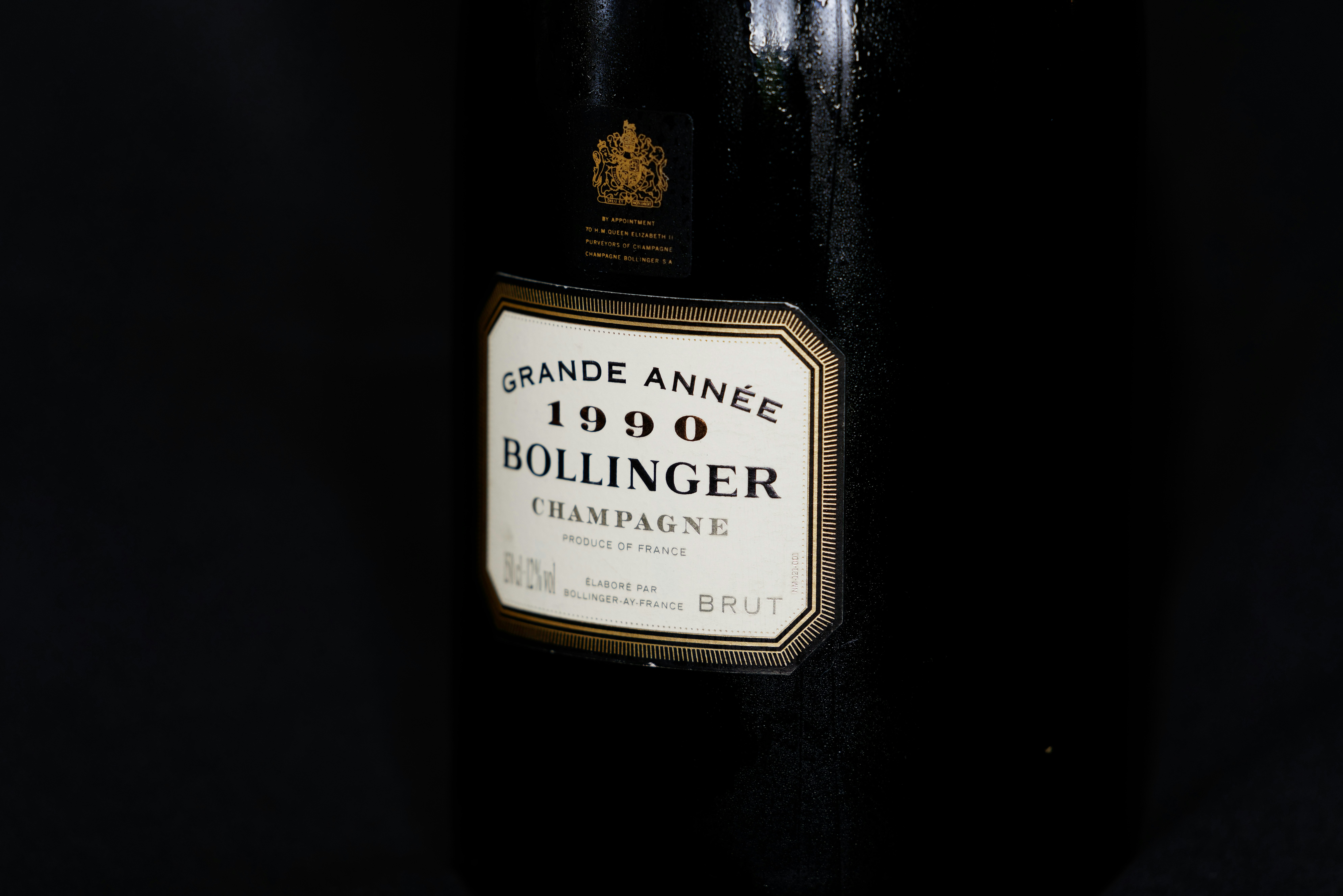 Close-up of a 1990 Bollinger Champagne Grande Année label on a dark magnum bottle.