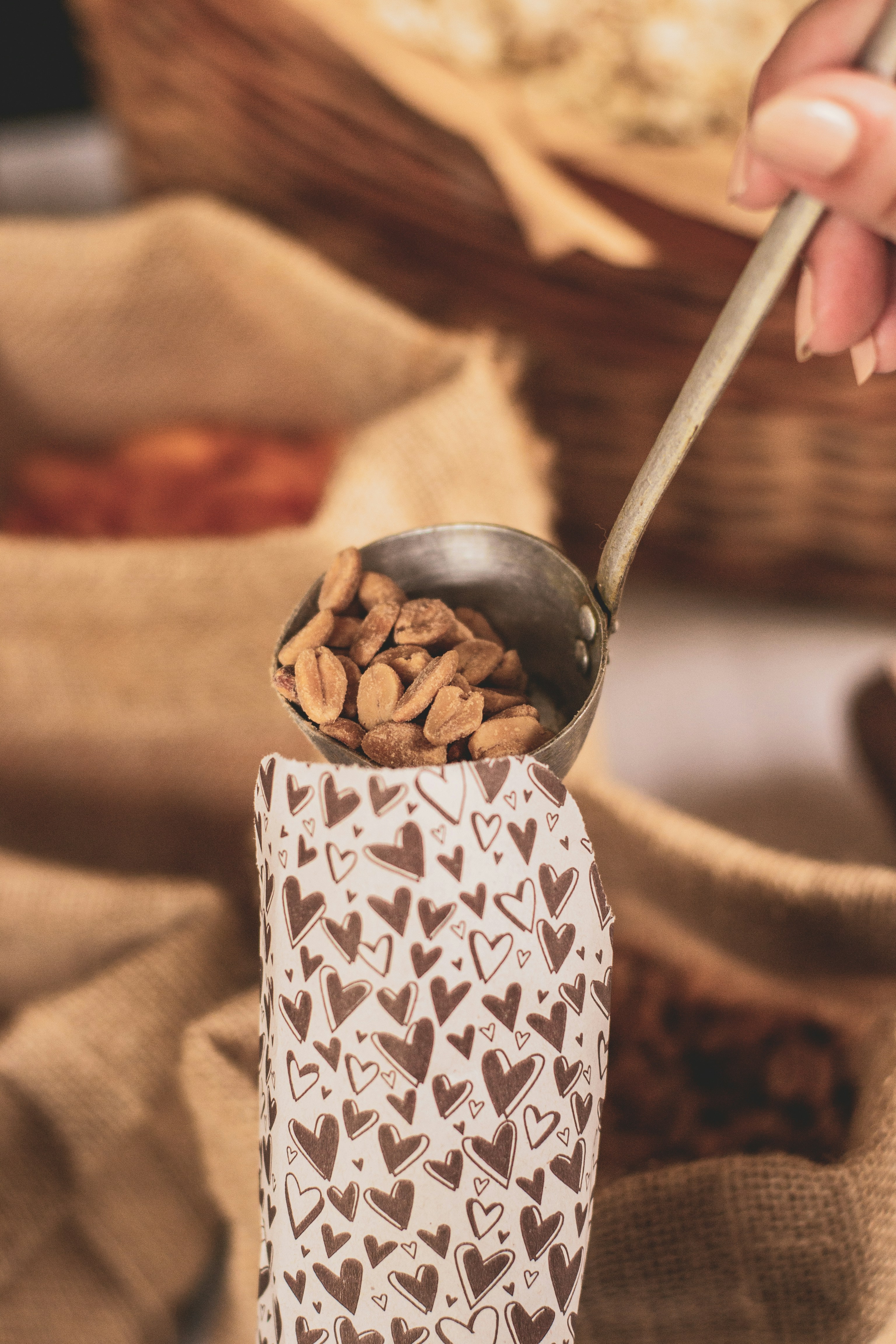 A Copper Spoon Delicacy: Measuring Cocoa Nuts into a Heart‑Patterned Cone