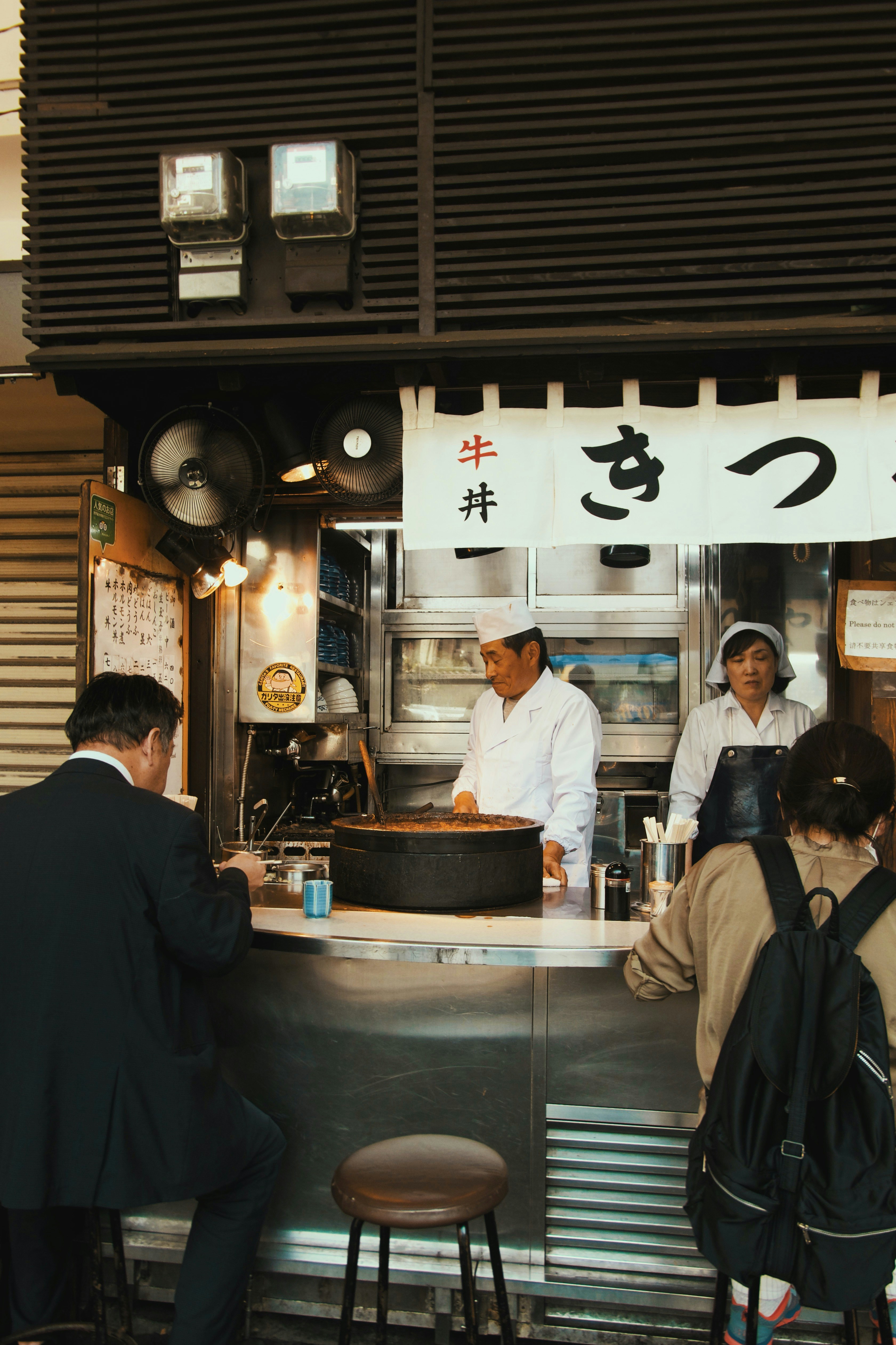 Two person sitting beside counter photo – Free Grey Image on Unsplash