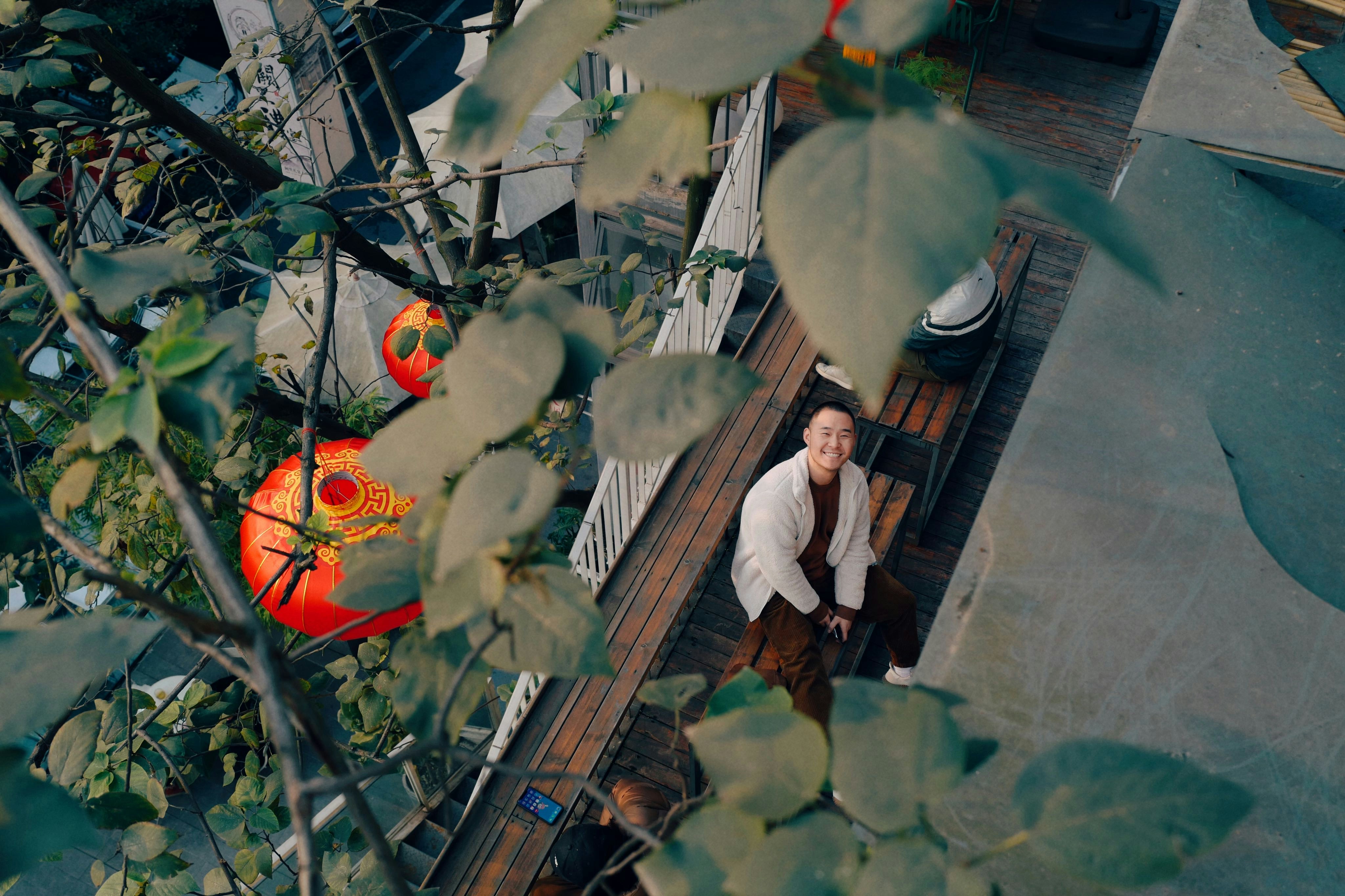 Lanterns, Leaves, and a Moment on the Wooden Balcony