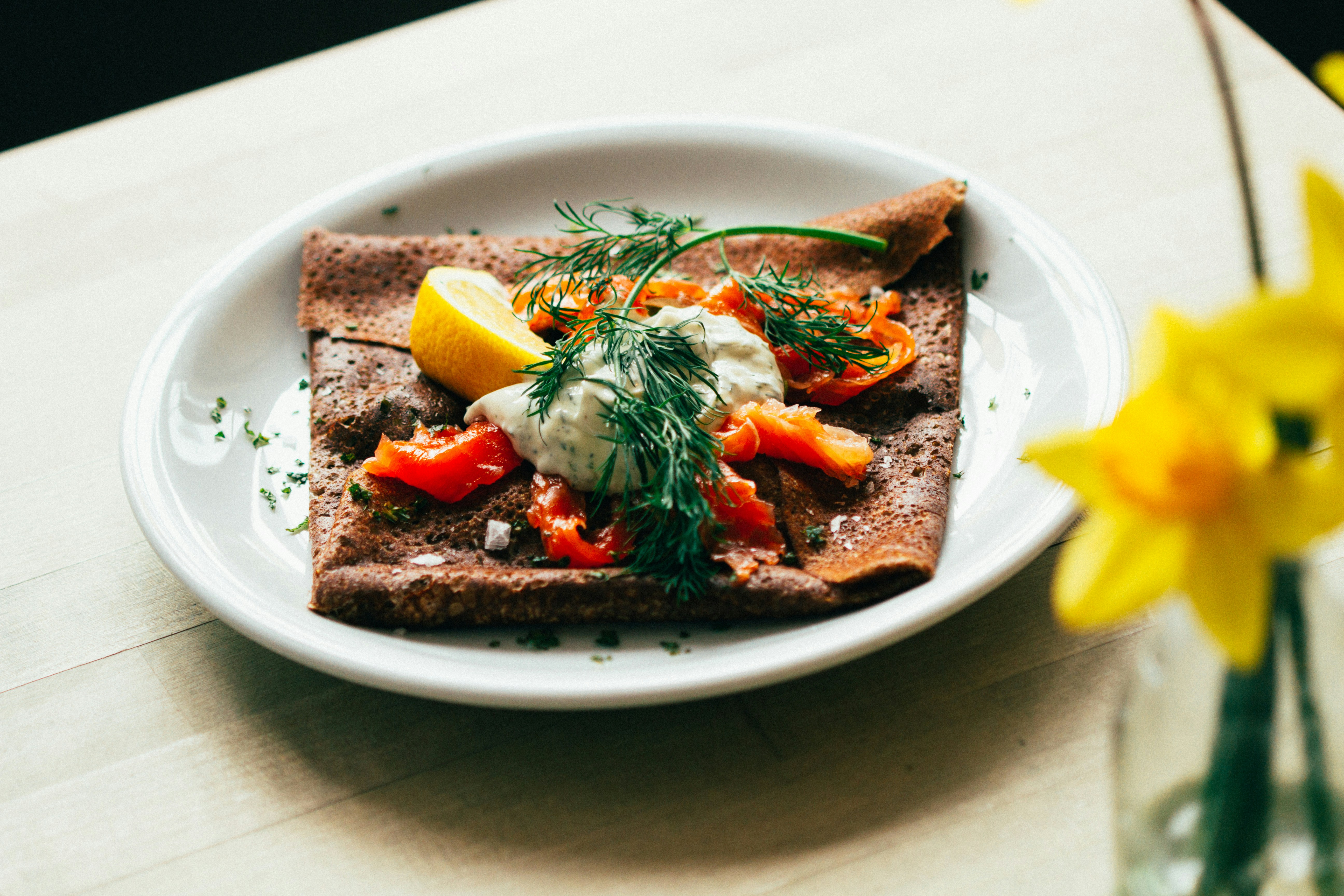 A savoury salmon galette with lemon and dill with daffodil.