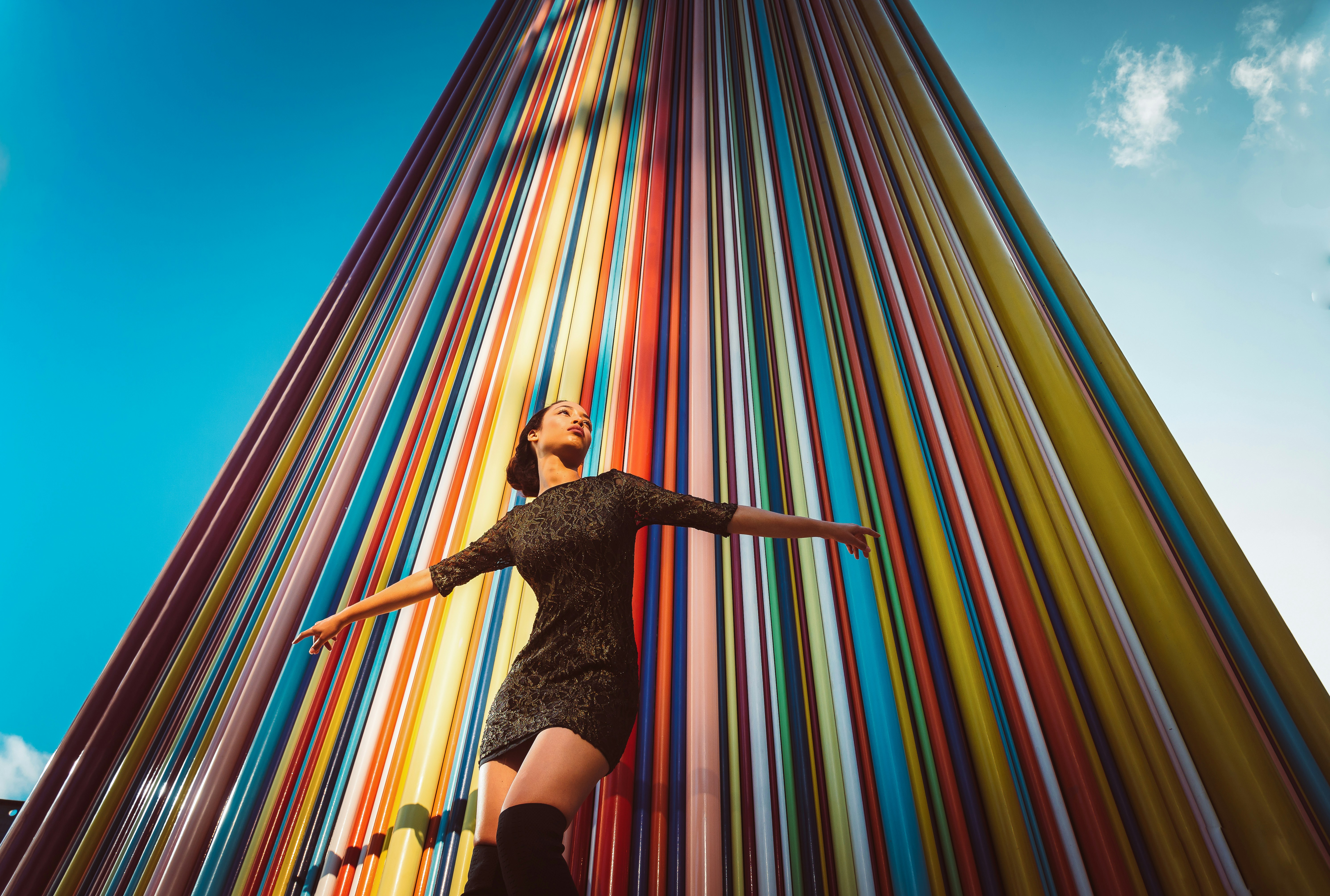 Chromatic Pillars: A Figure in a Velvet Dress Among Vertical Stripes