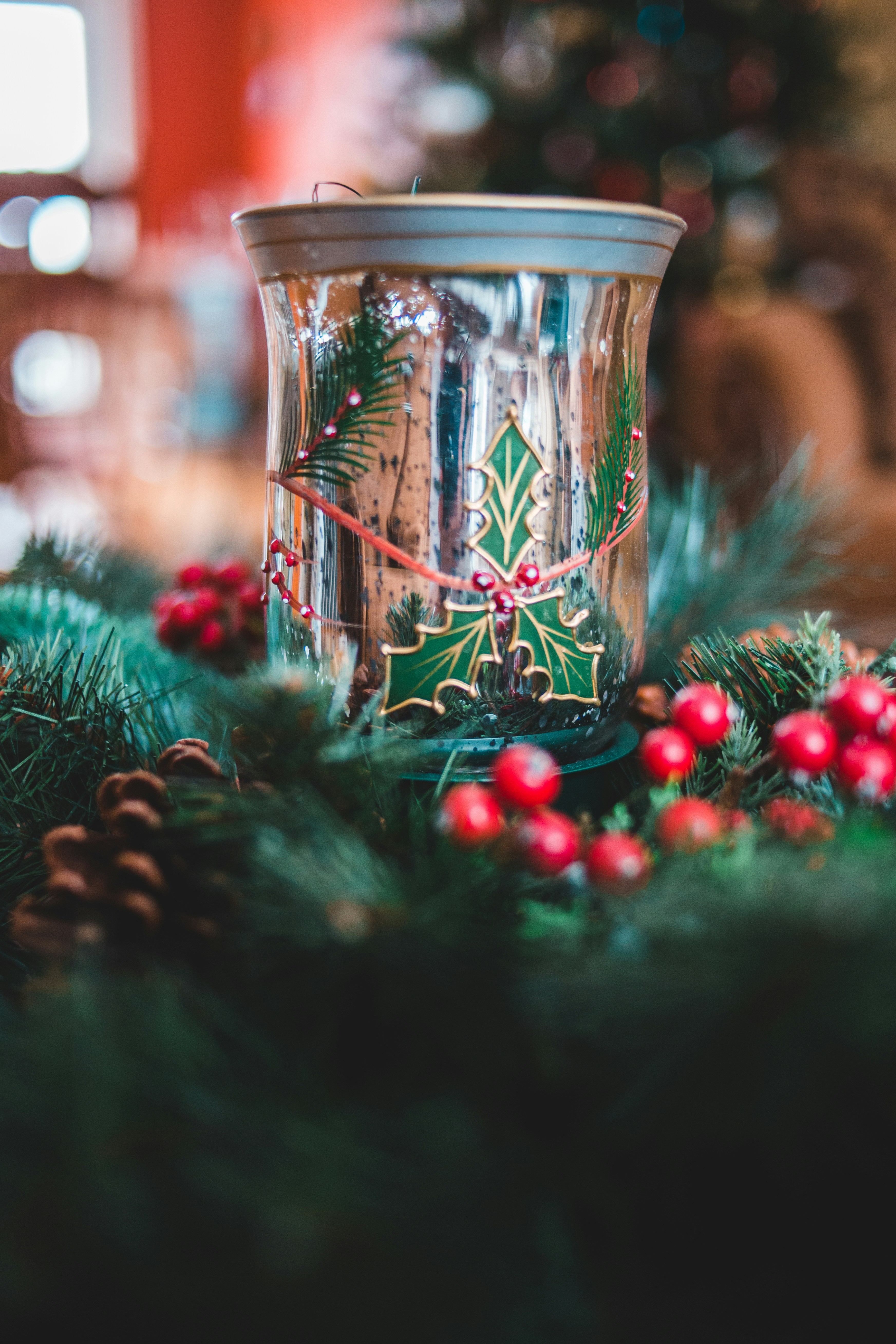 Holiday Glow: A Glass Jar centerpiece Framed by Evergreen Fronds
