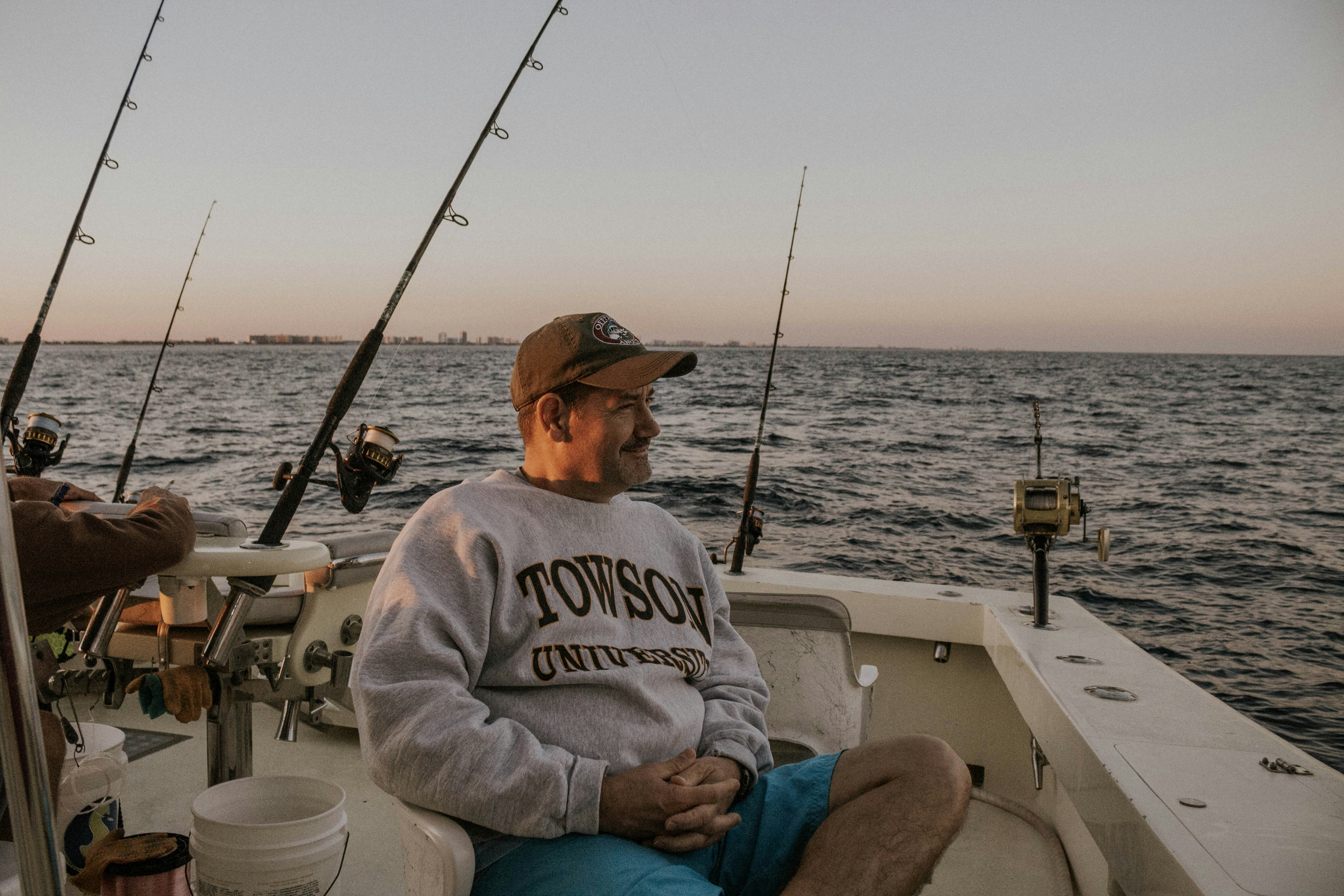 Towson Sunset: A Casual Angler's Quiet Moment on a Fishing Boat