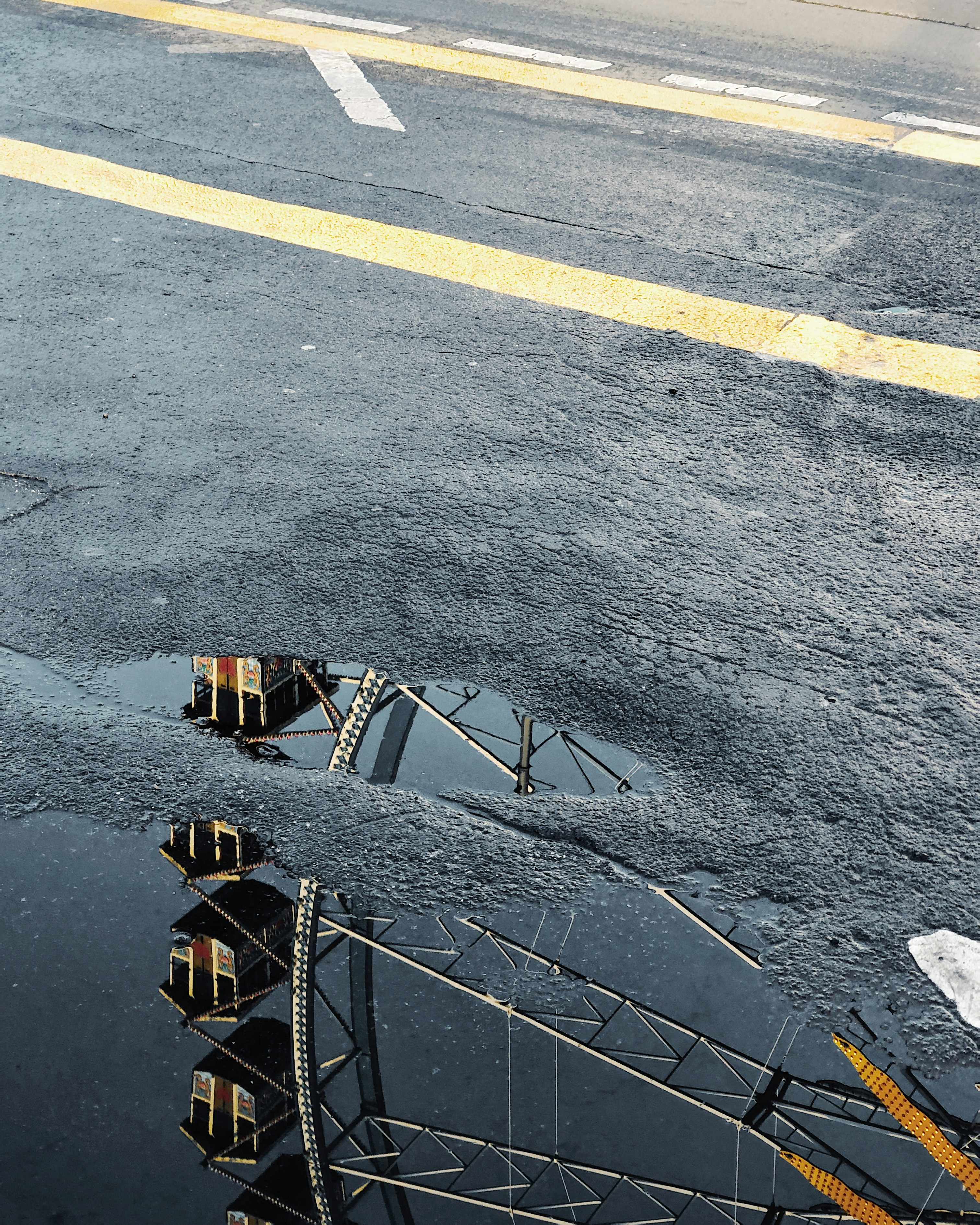 Steel Lattice Mirage: Reflections in a Rain-Washed Puddle