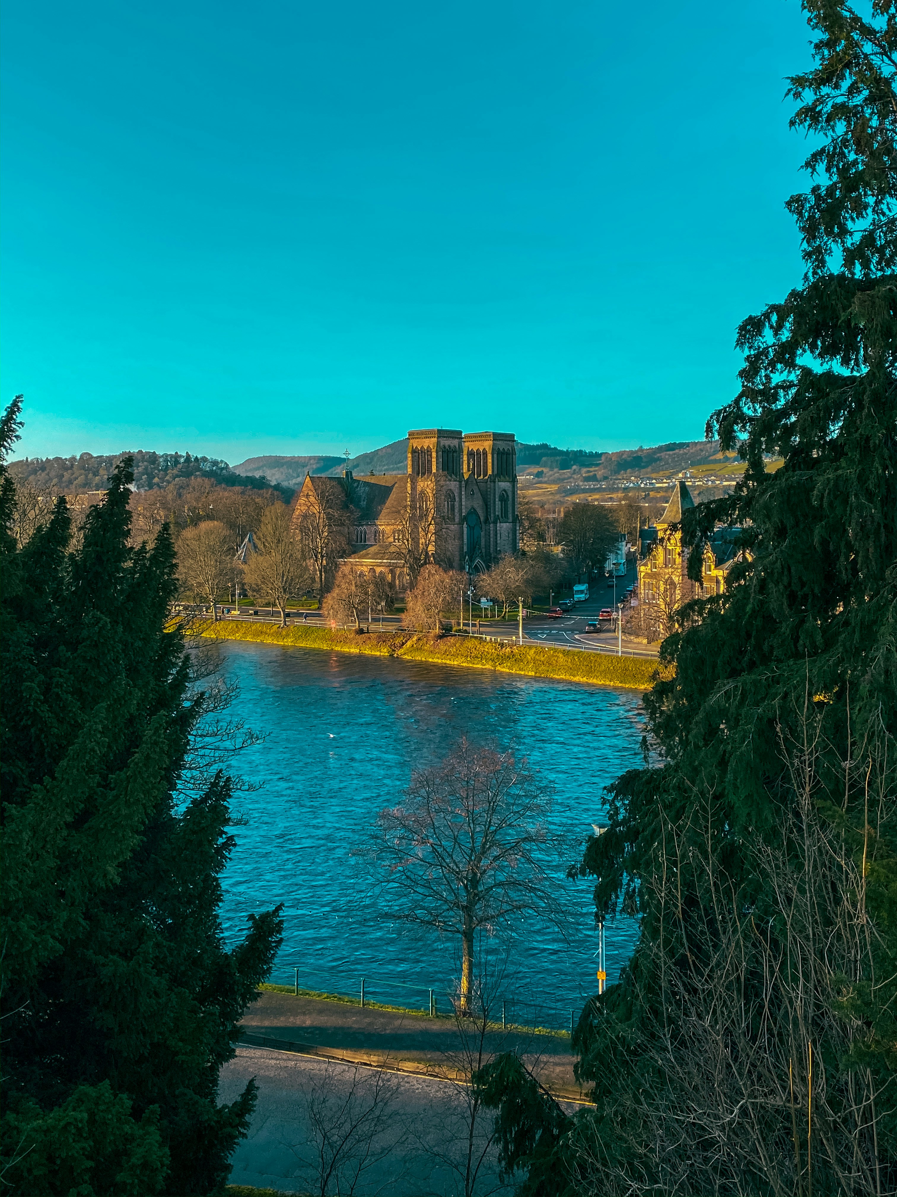 brown castle near body of water viewing mountain during daytime