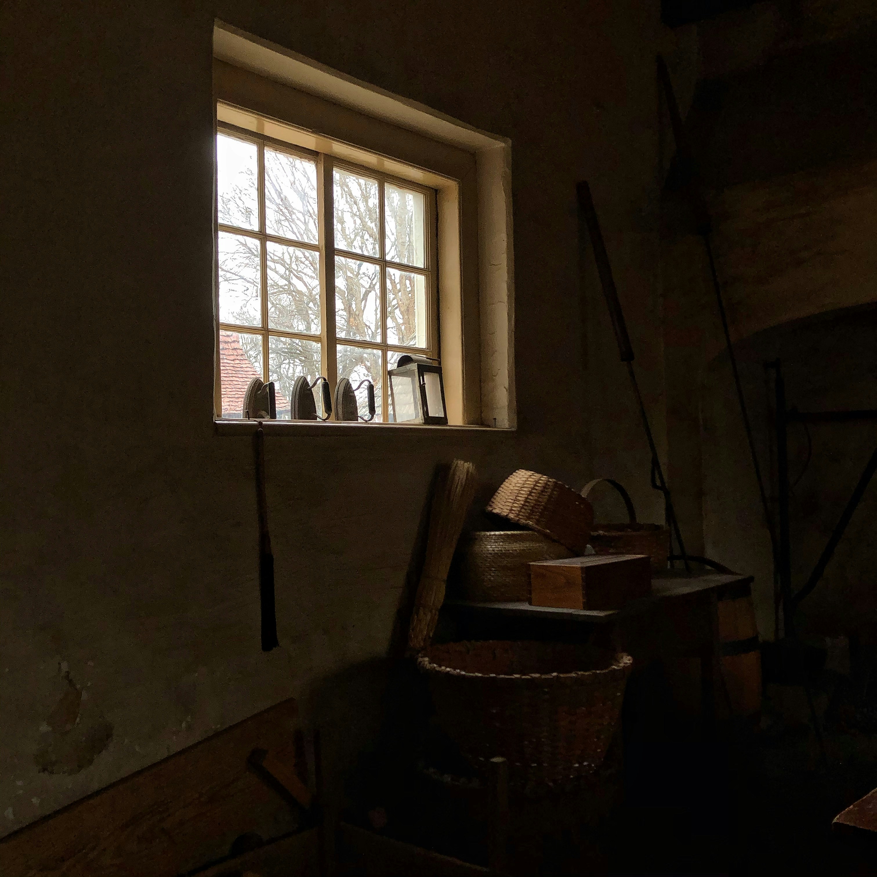 Quiet Workshop Dawn: Light Filtering Through a Rustic Window