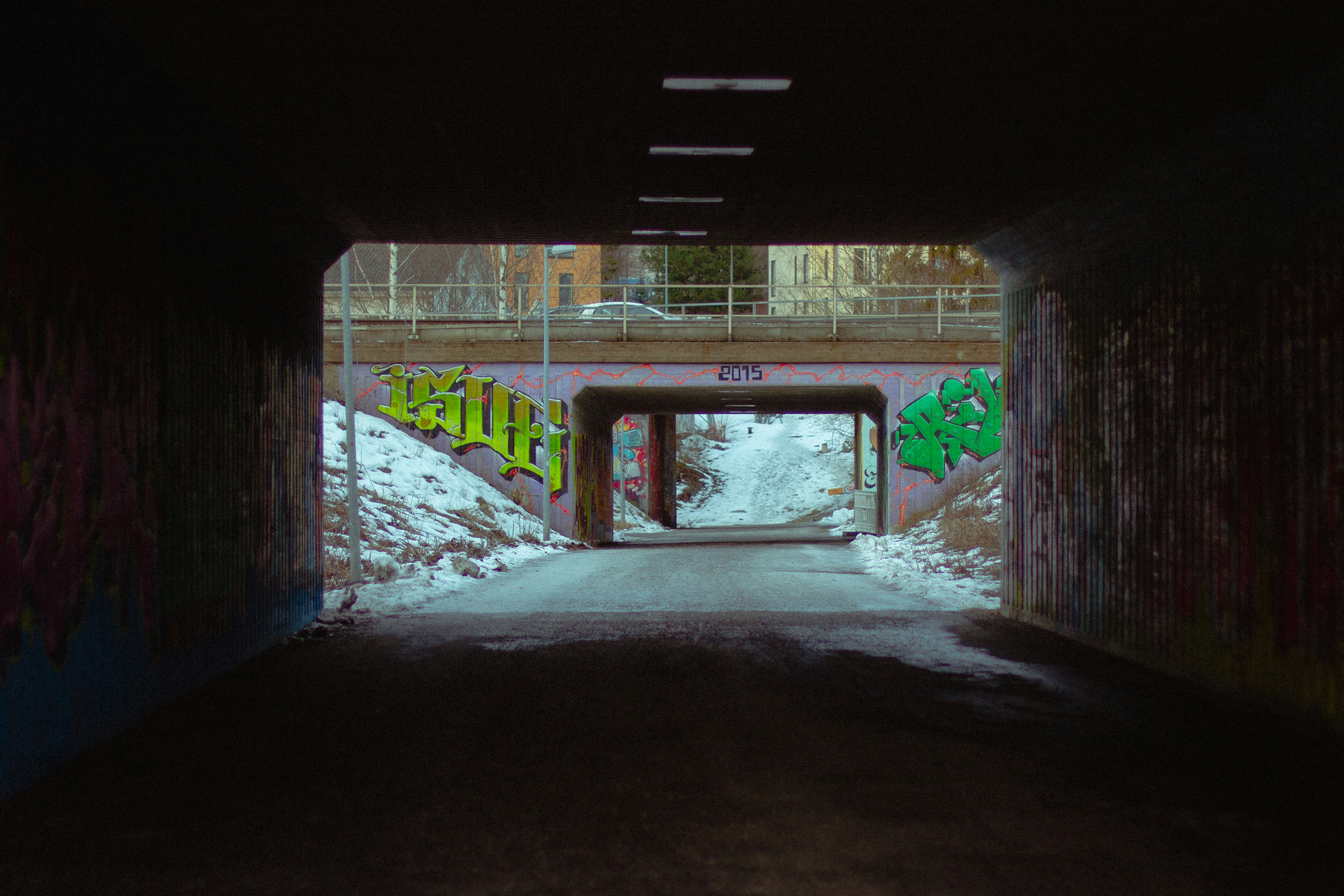 Underpass Horizon: Snow-Covered Tunnel with Graffiti