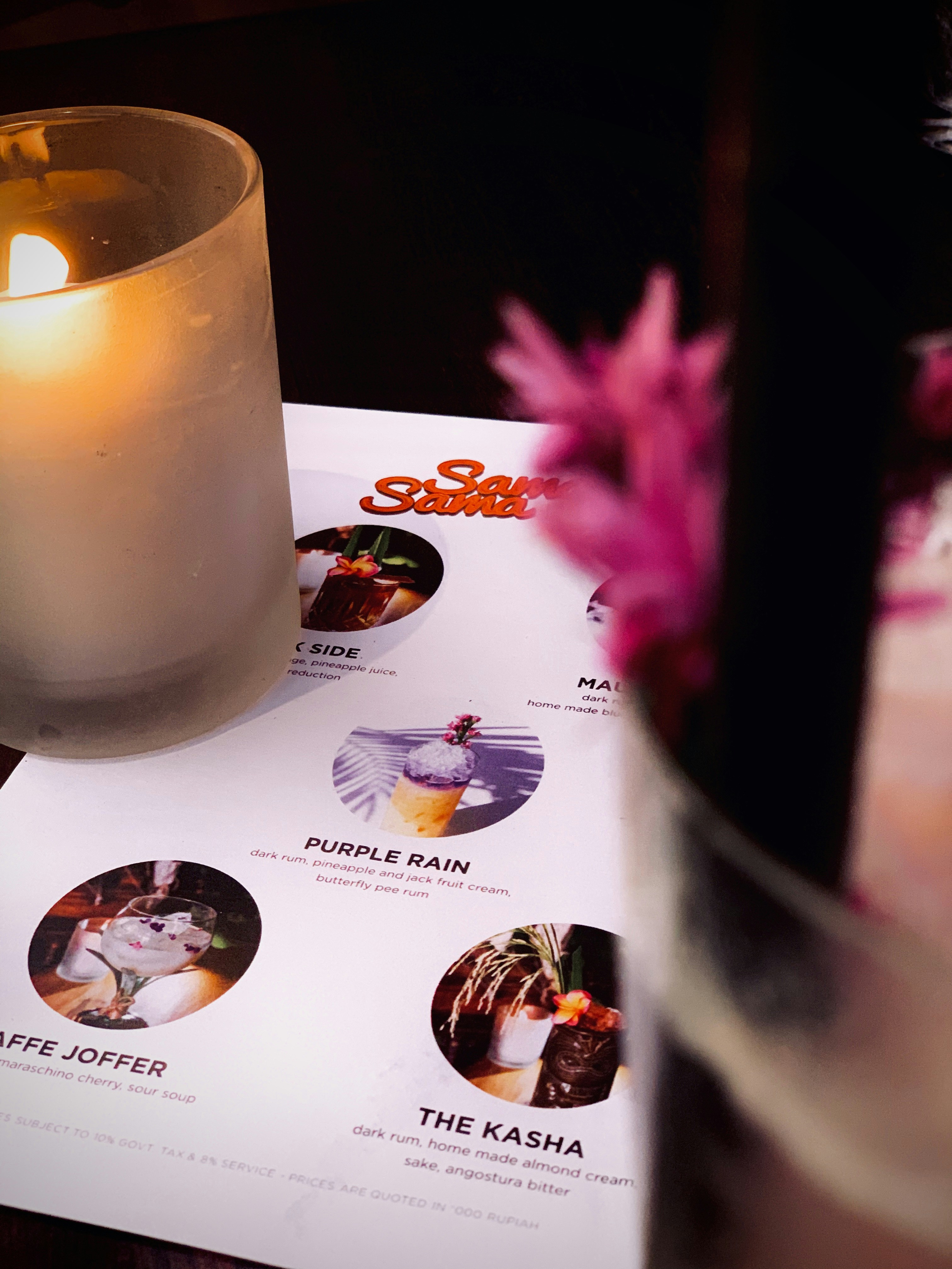 Candlelight Menu: soft glow and blurred violet bloom over a café menu