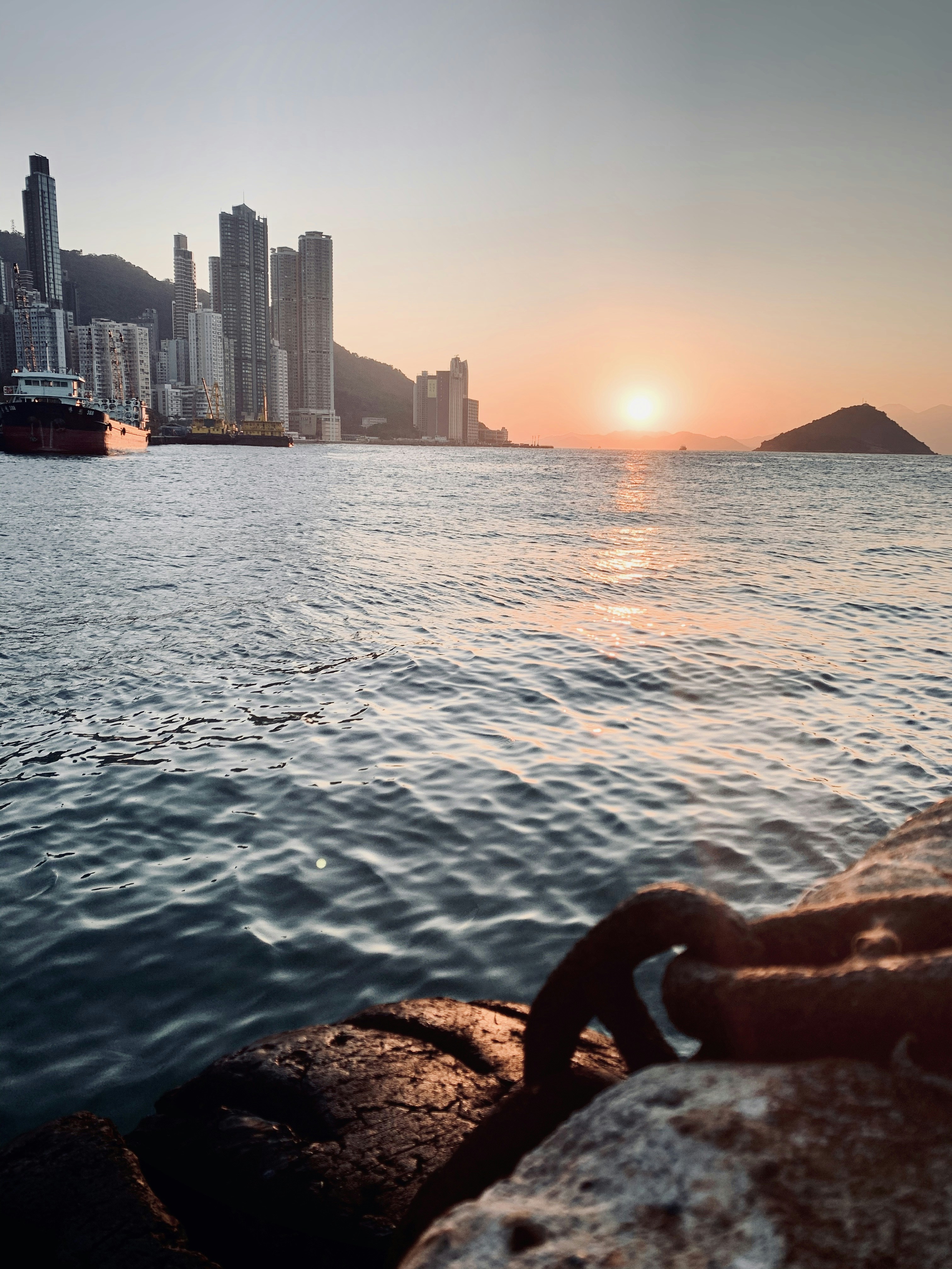 City with high-rise buildings viewing body of water and island during ...
