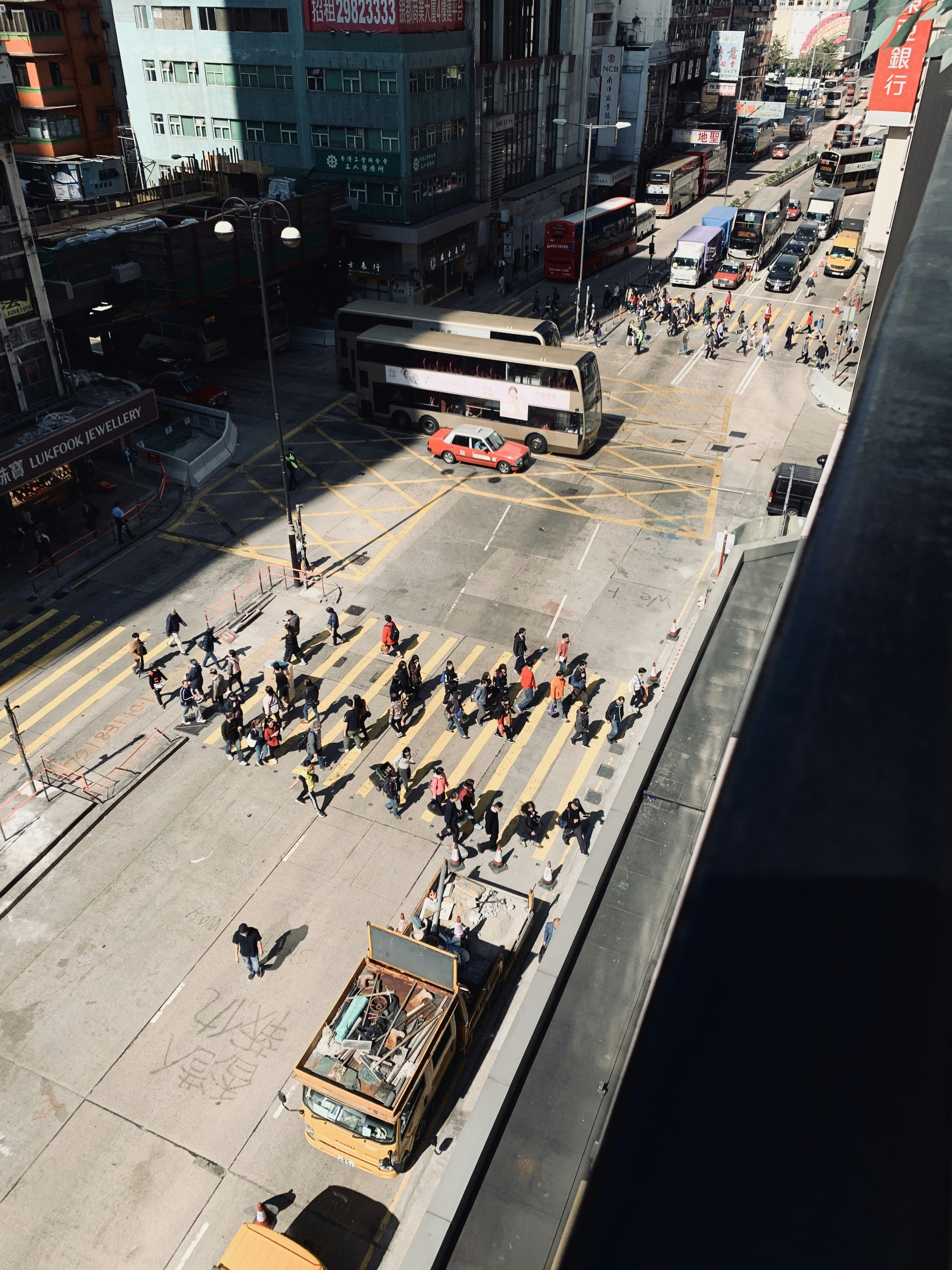 People crossing on pedestal lane and different vehicles on road beside ...