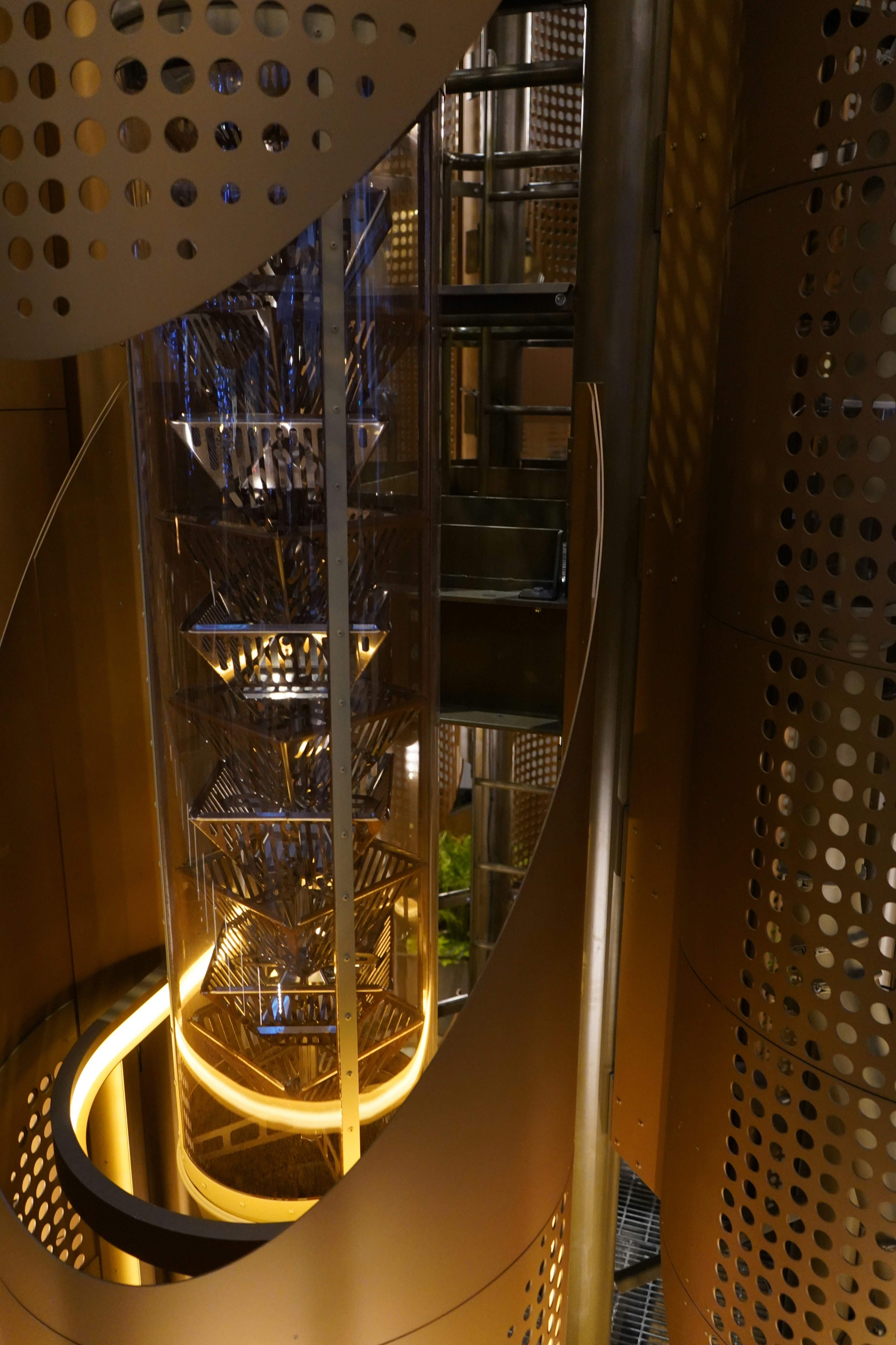 Glowing Helix: Night ascent through a perforated steel atrium