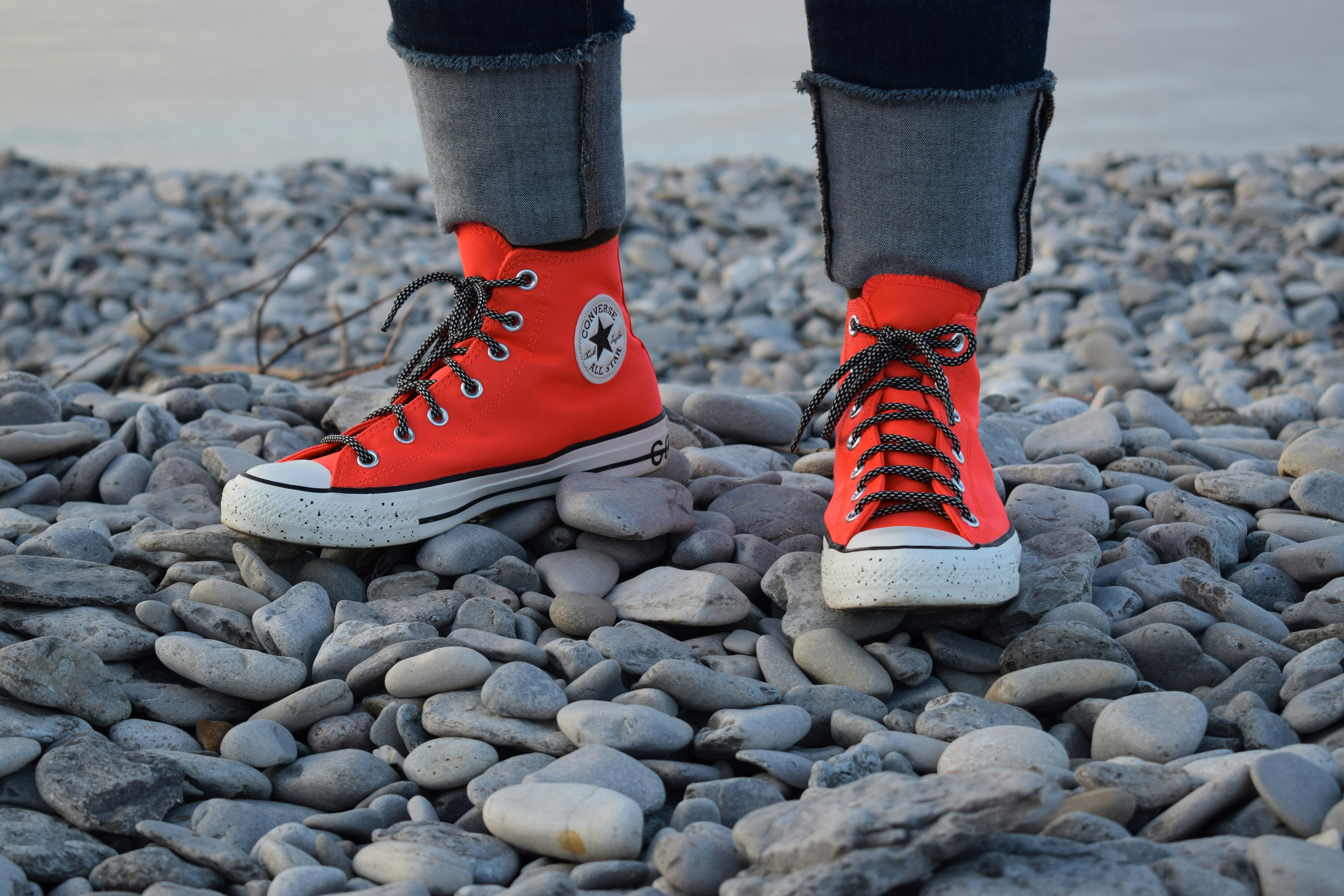 GORE-TEX Coverse on a chunky rocky beach.