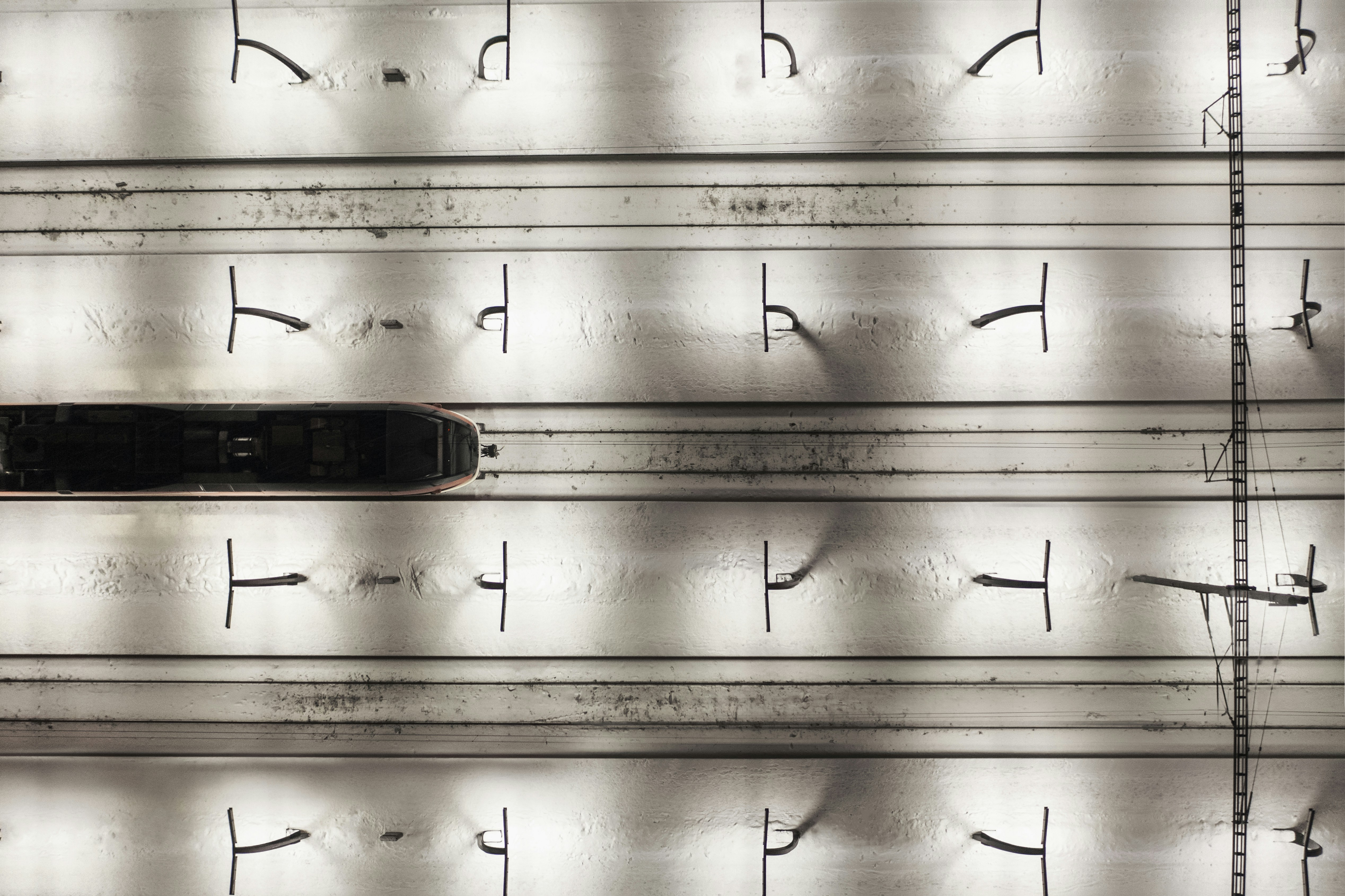 Train navigates snow-covered tracks under soft lighting.