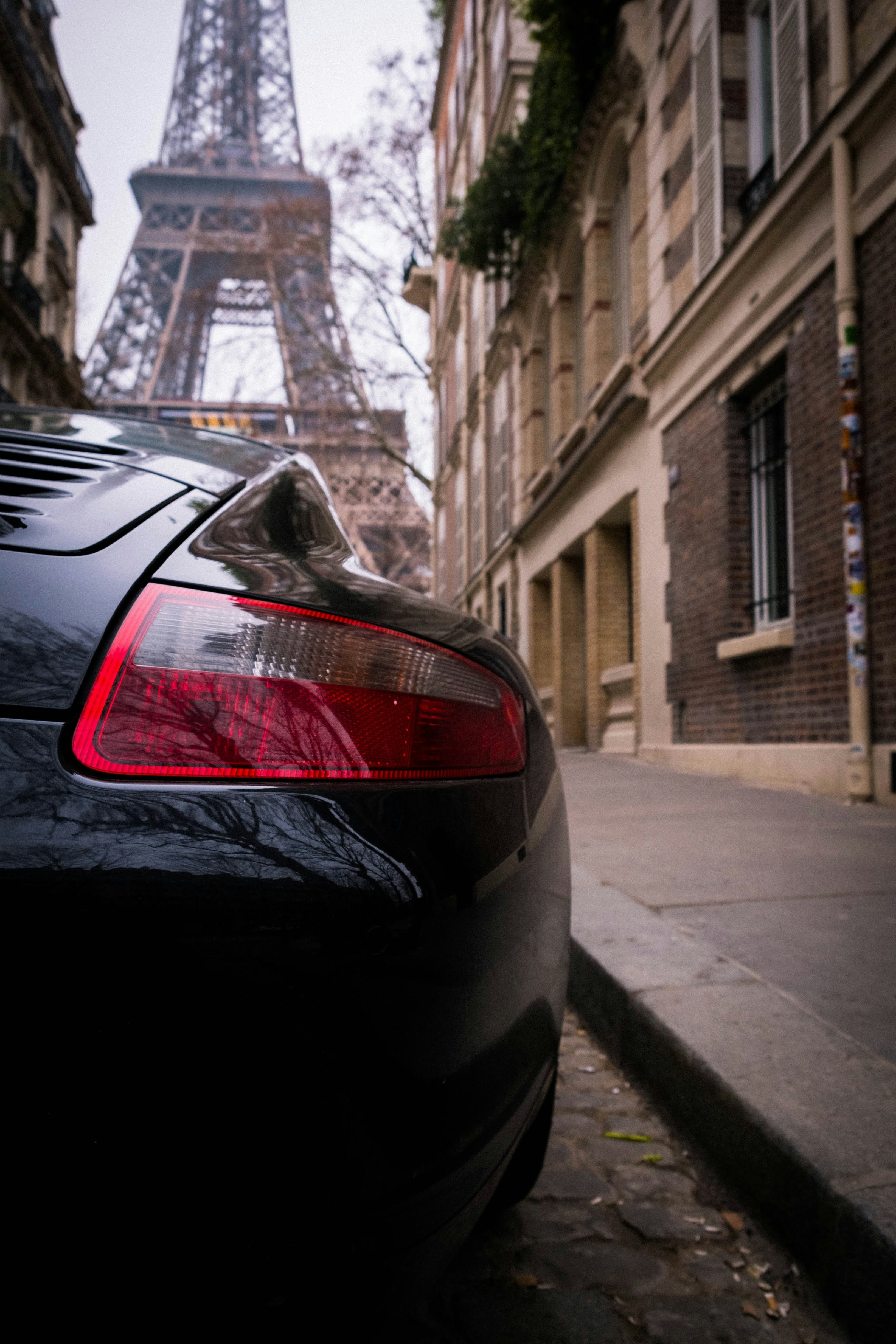 Parisian Tail Light: A Car's Perspective with the Eiffel Tower in Frame